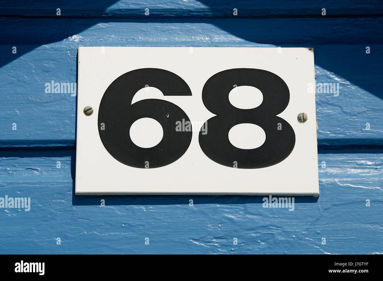The number 68 on a beach hut Stock Photo - Alamy