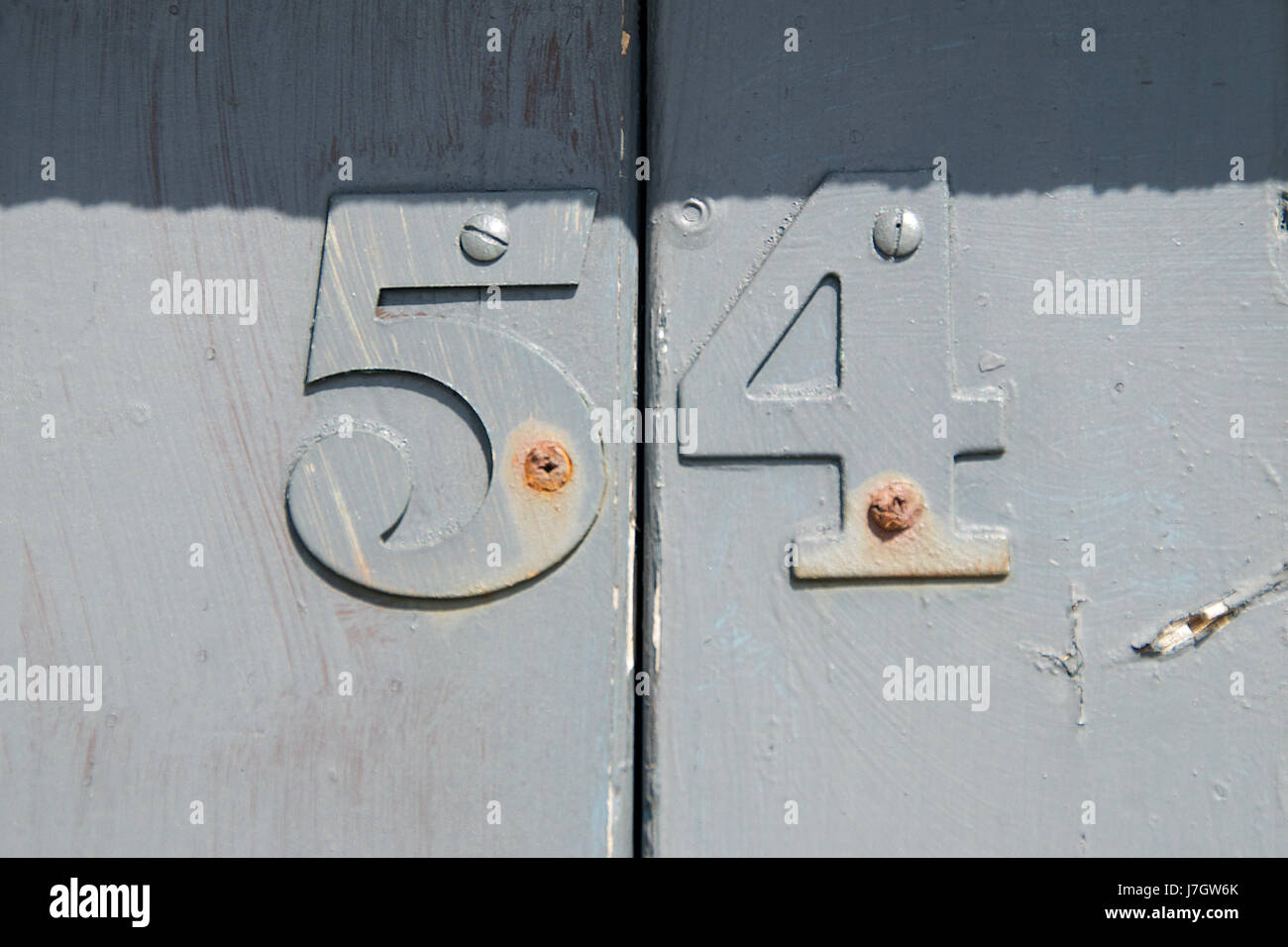 The number 54 on a beach hut Stock Photo - Alamy