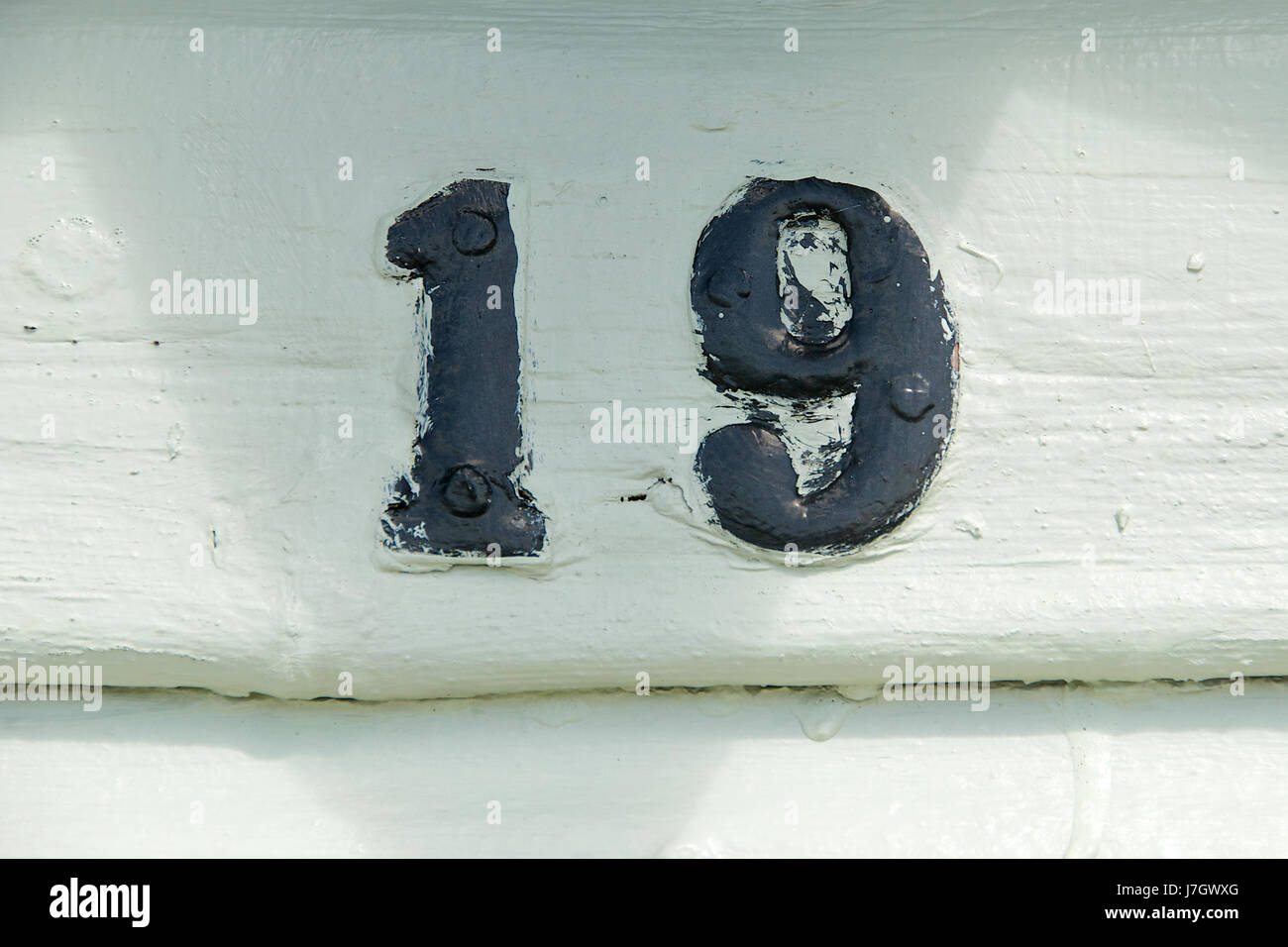 The number 19 on a beach hut Stock Photo - Alamy