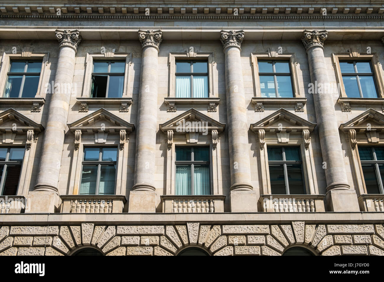 Windows on historic building facade with columns Stock Photo - Alamy