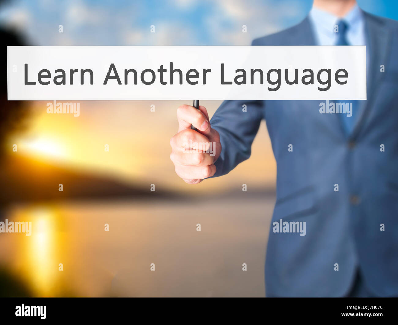 Learn Another Language - Businessman hand holding sign. Business ...