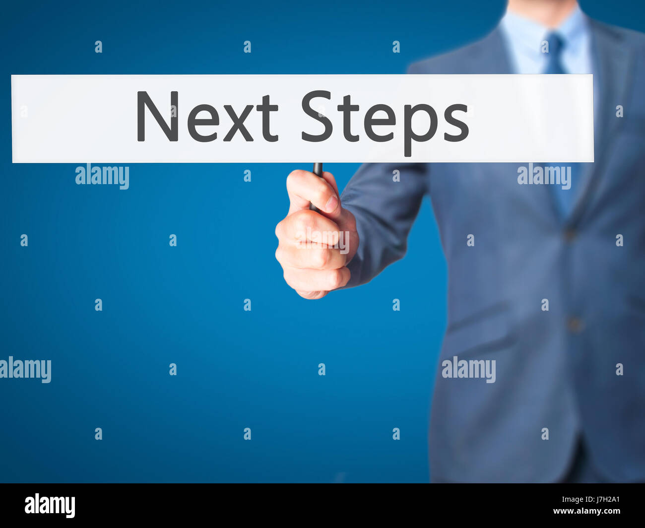 Next Steps - Business man showing sign. Business, technology, internet ...