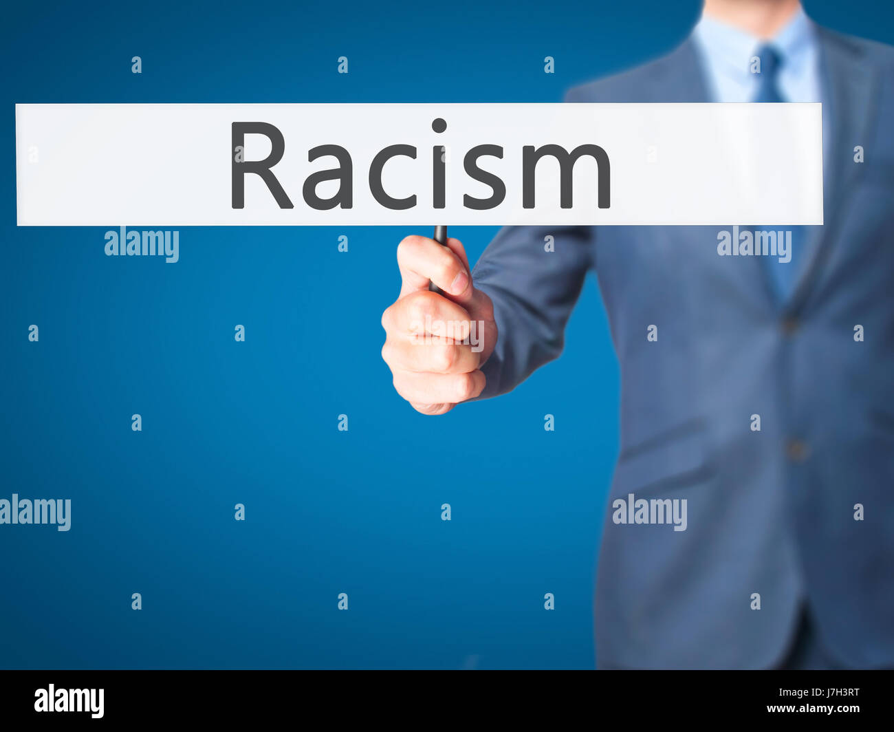 Racism - Businessman hand holding sign. Business, technology, internet ...
