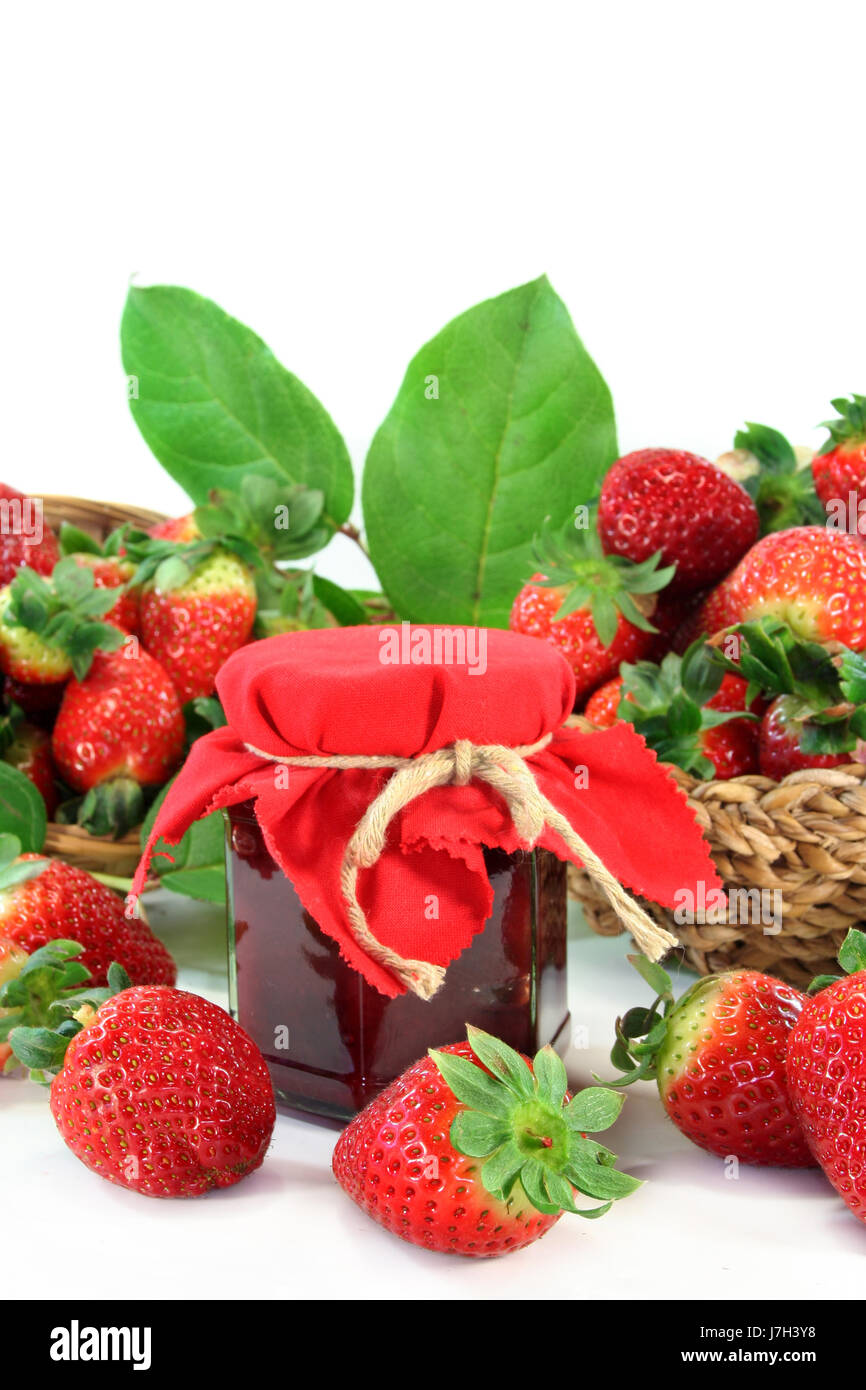 a jar of jam and fresh fruit against white background Stock Photo - Alamy