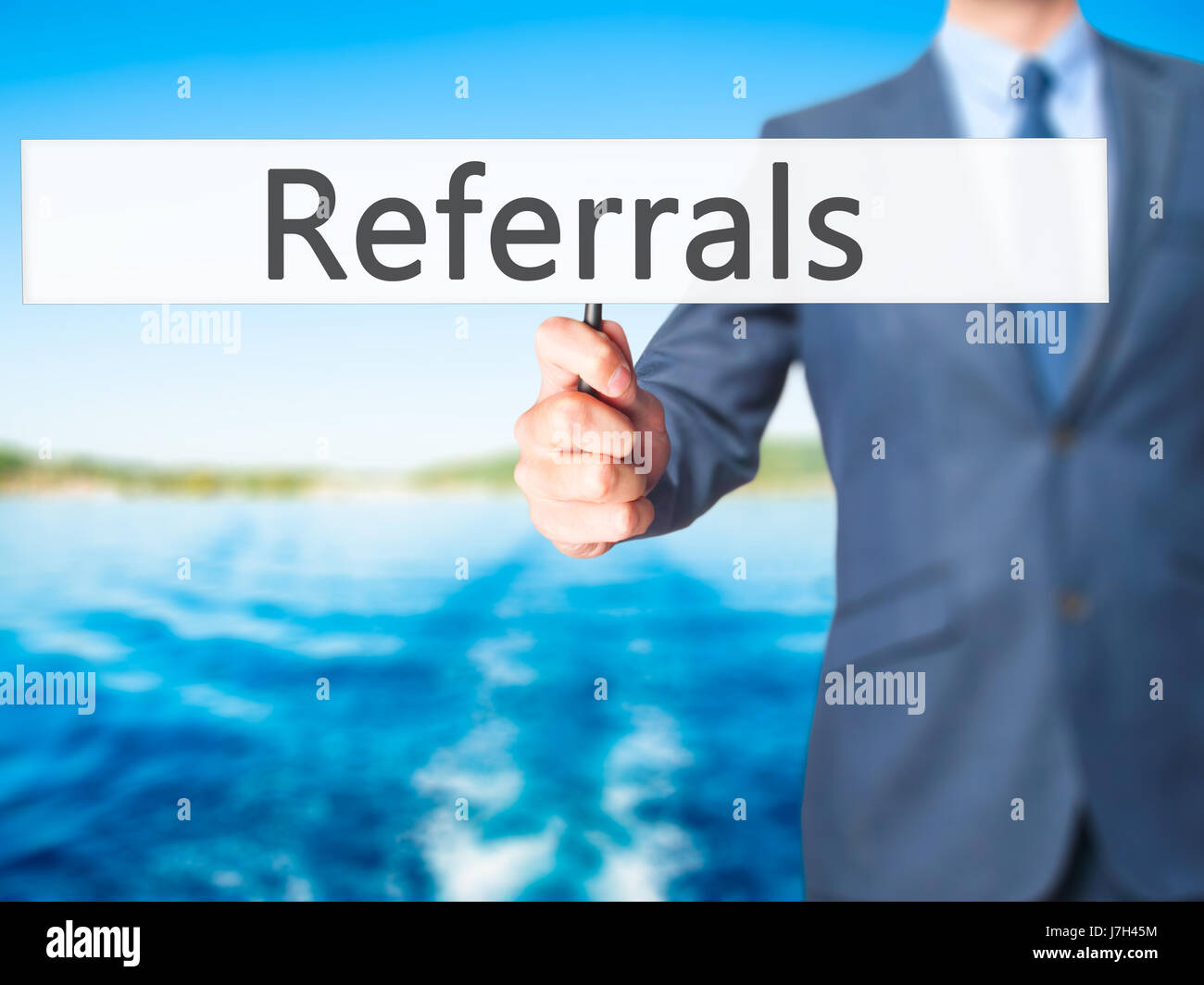 Referrals - Businessman hand holding sign. Business, technology ...