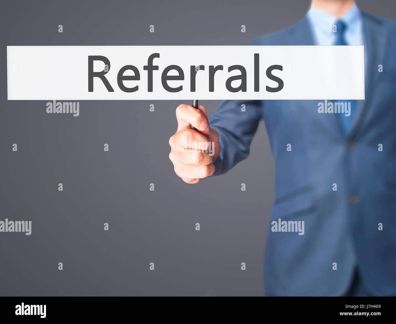 Referrals - Businessman hand holding sign. Business, technology ...