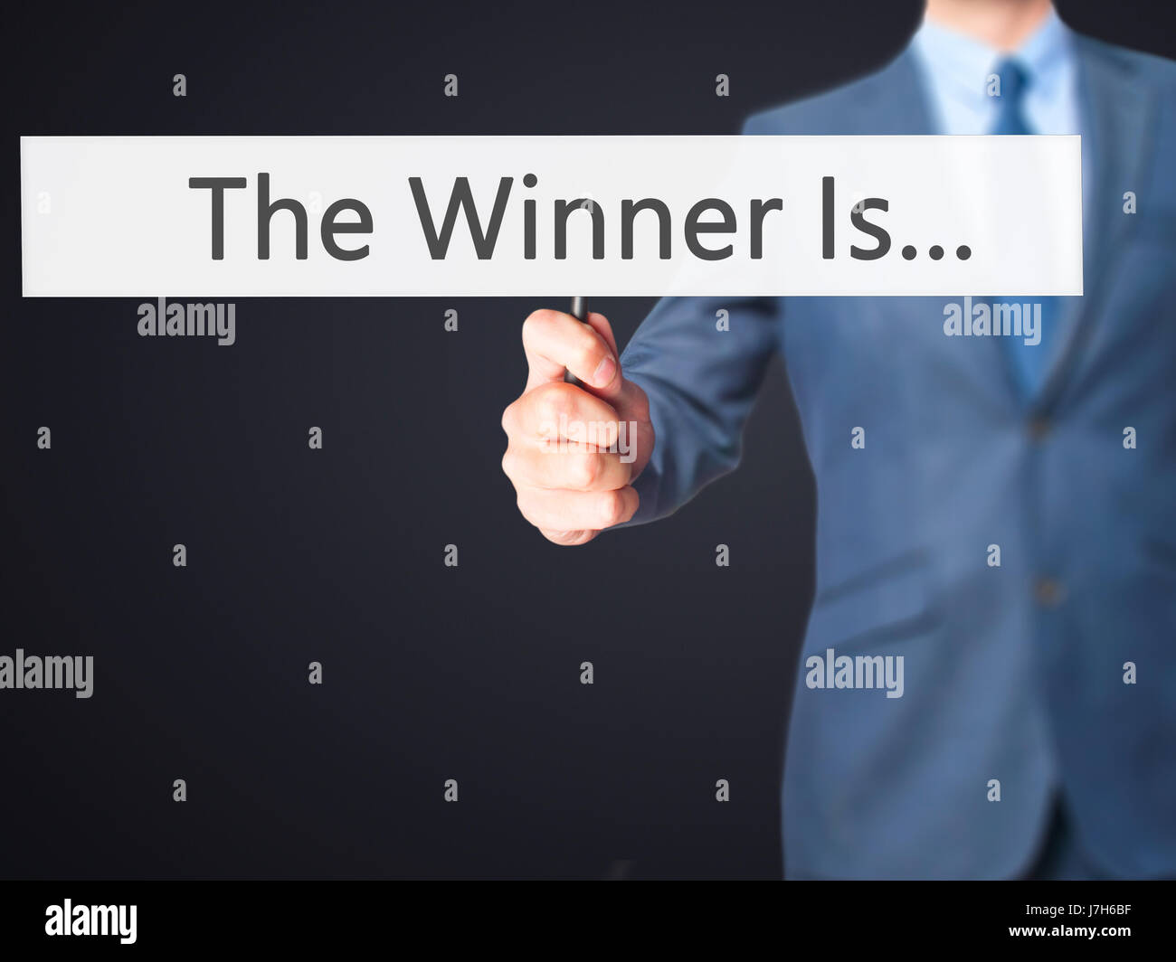 The Winner Is... - Businessman hand holding sign. Business, technology ...