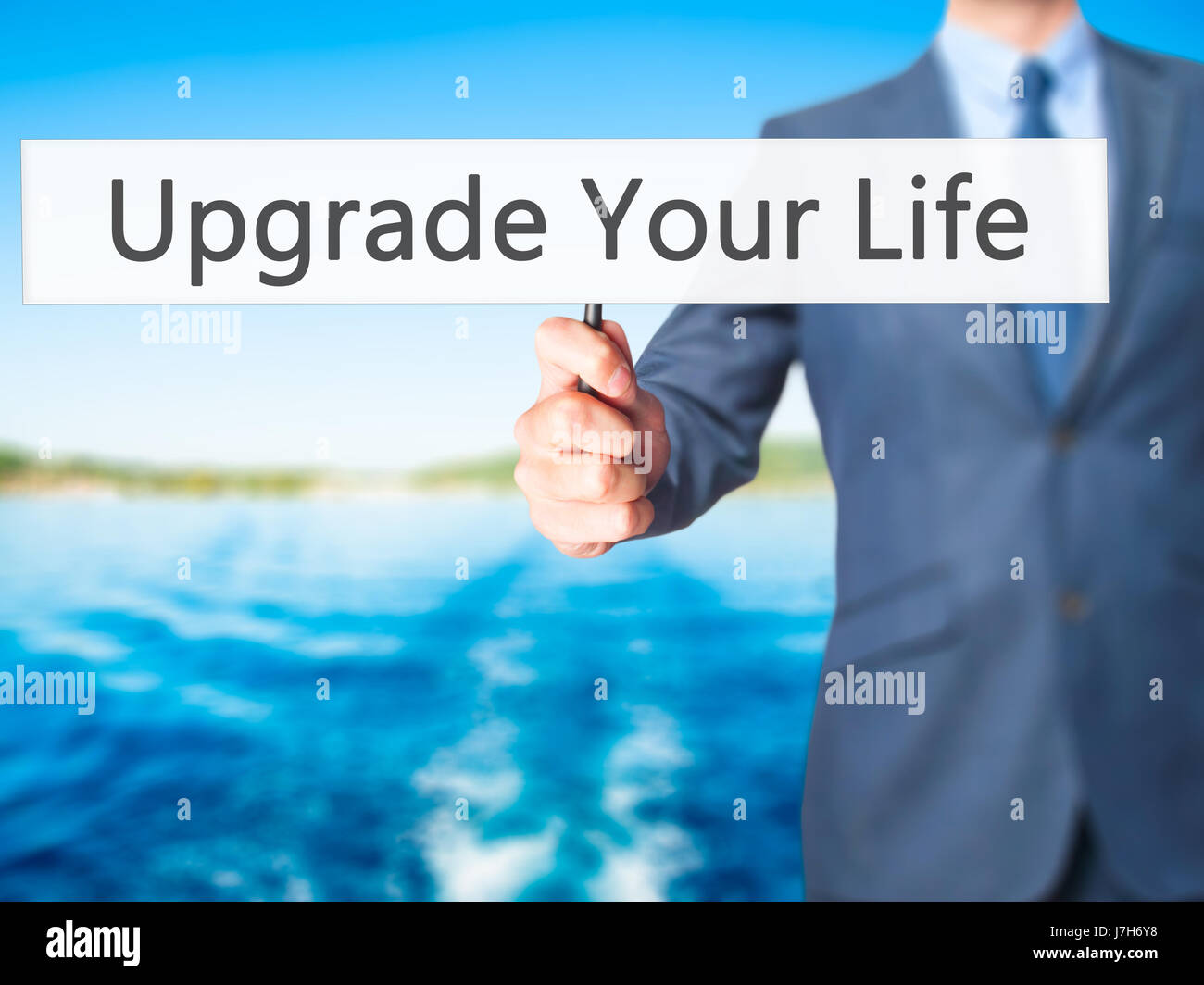 Upgrade Your Life - Businessman hand holding sign. Business, technology ...