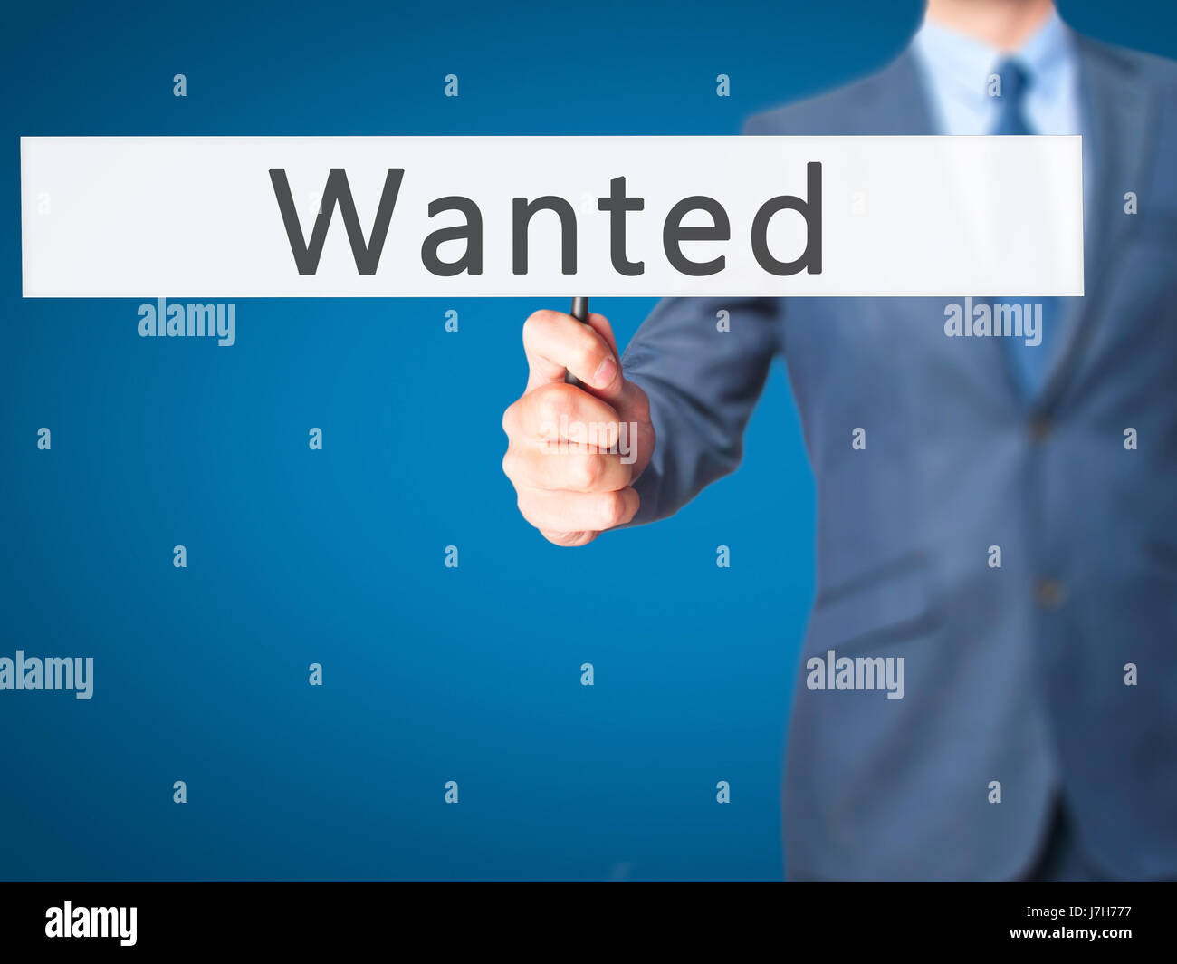 Wanted - Businessman hand holding sign. Business, technology, internet ...