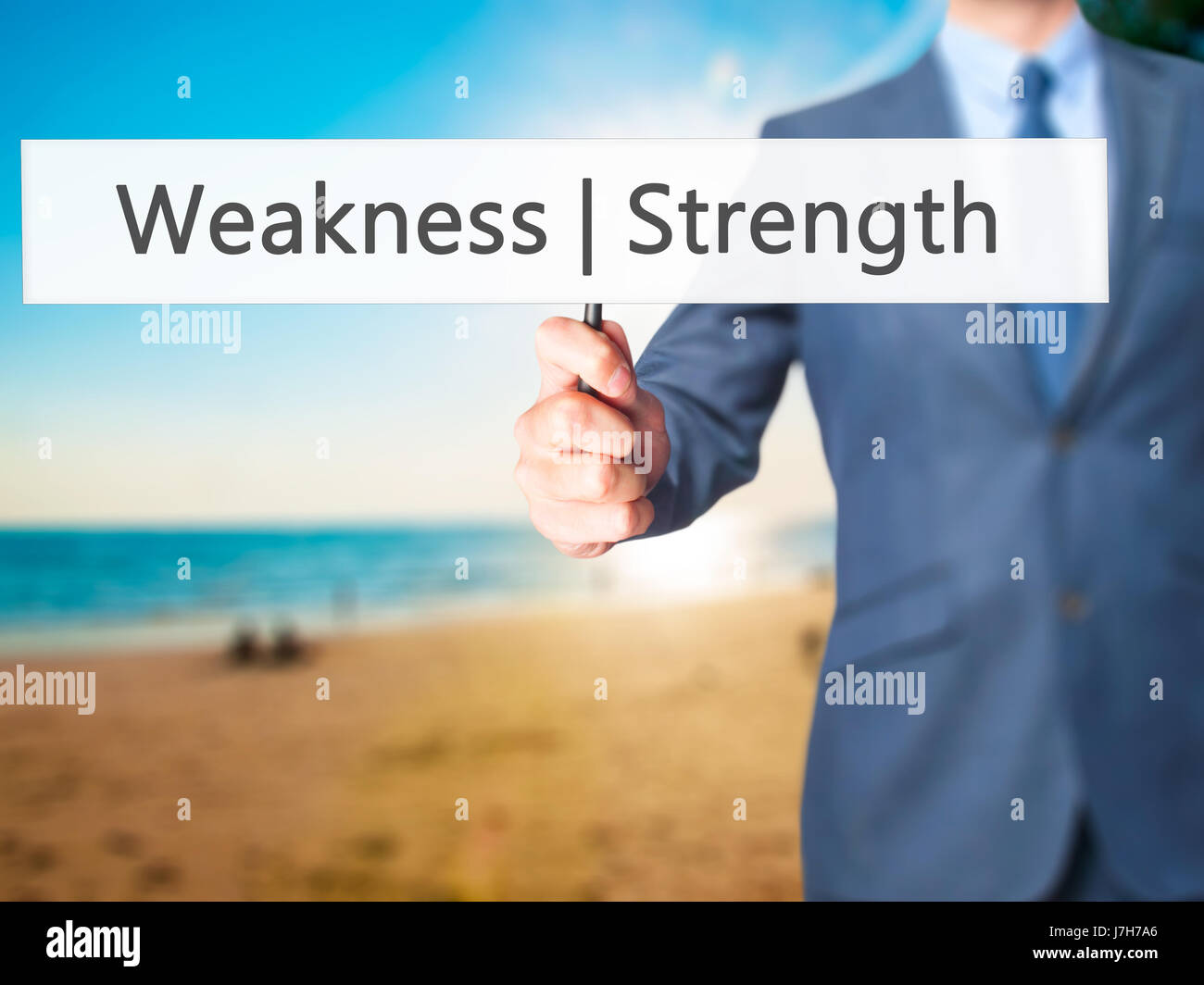 Weakness Strength - Businessman hand holding sign. Business, technology ...