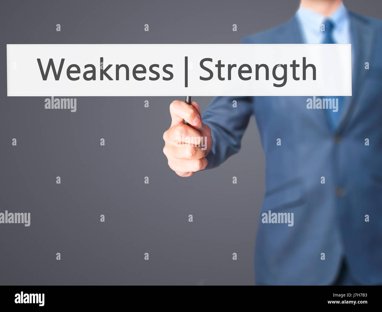 Weakness Strength - Businessman hand holding sign. Business, technology ...