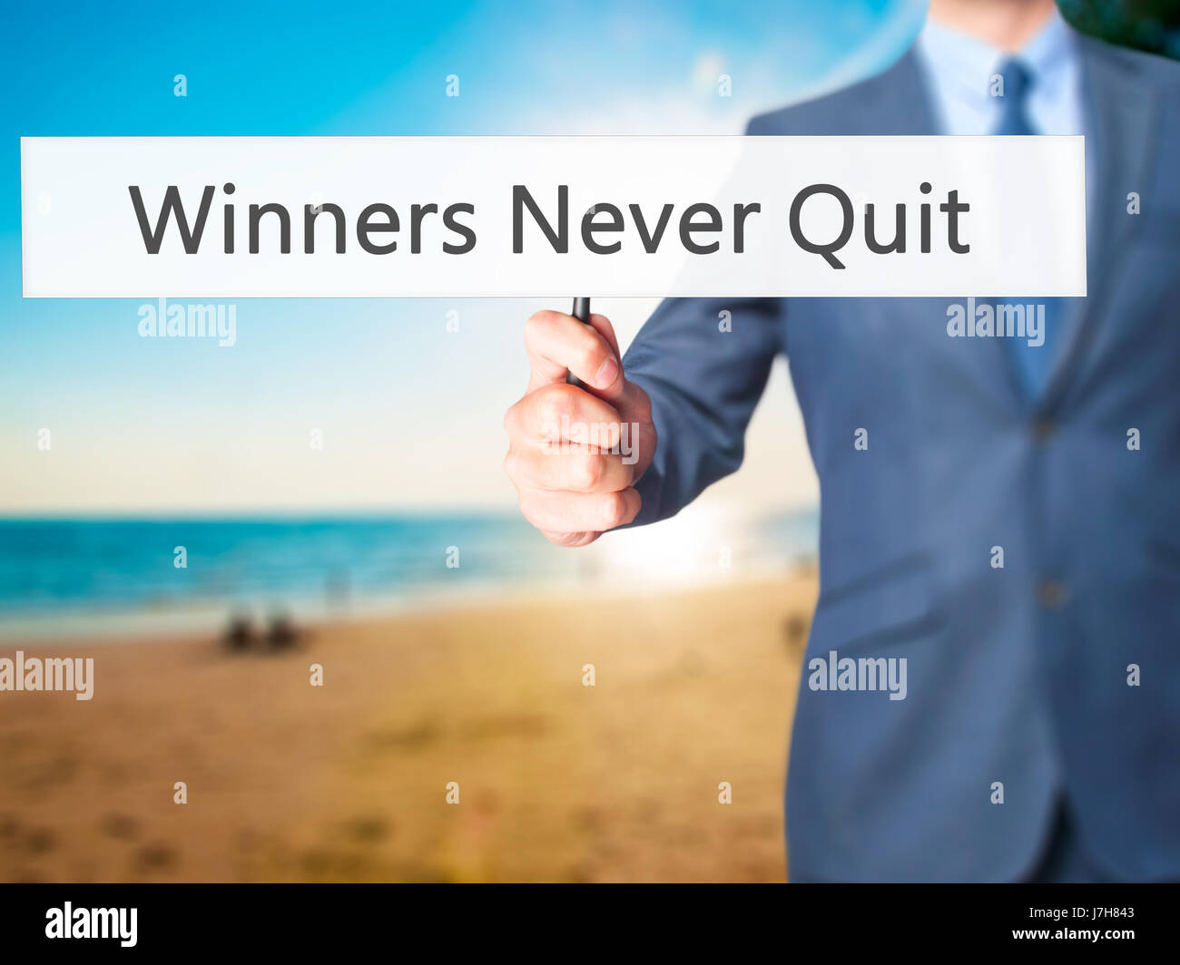 Winners Never Quit - Businessman hand holding sign. Business ...