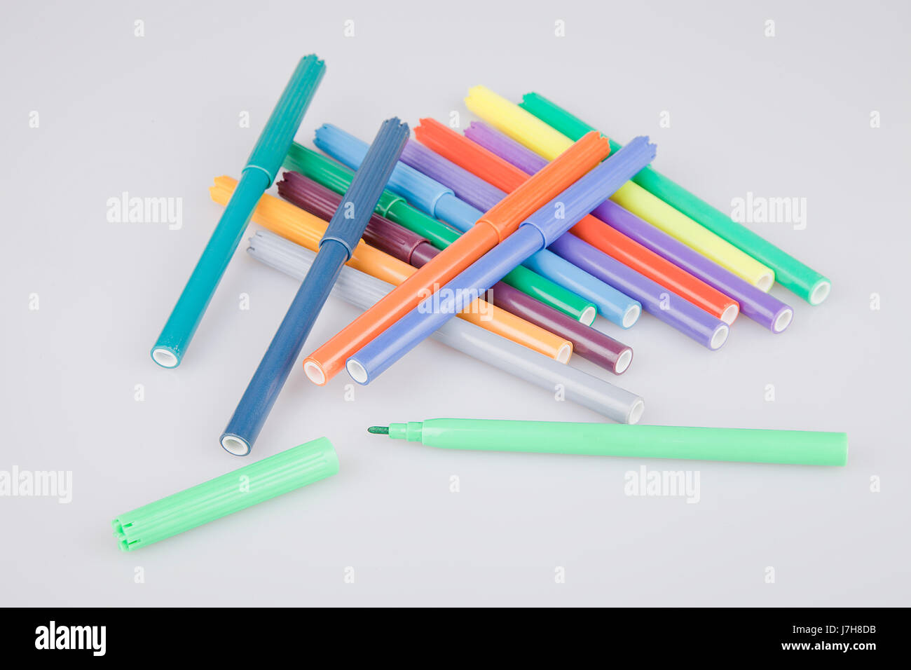 Colorful markers isolated on a white background. Focus on open marker ...