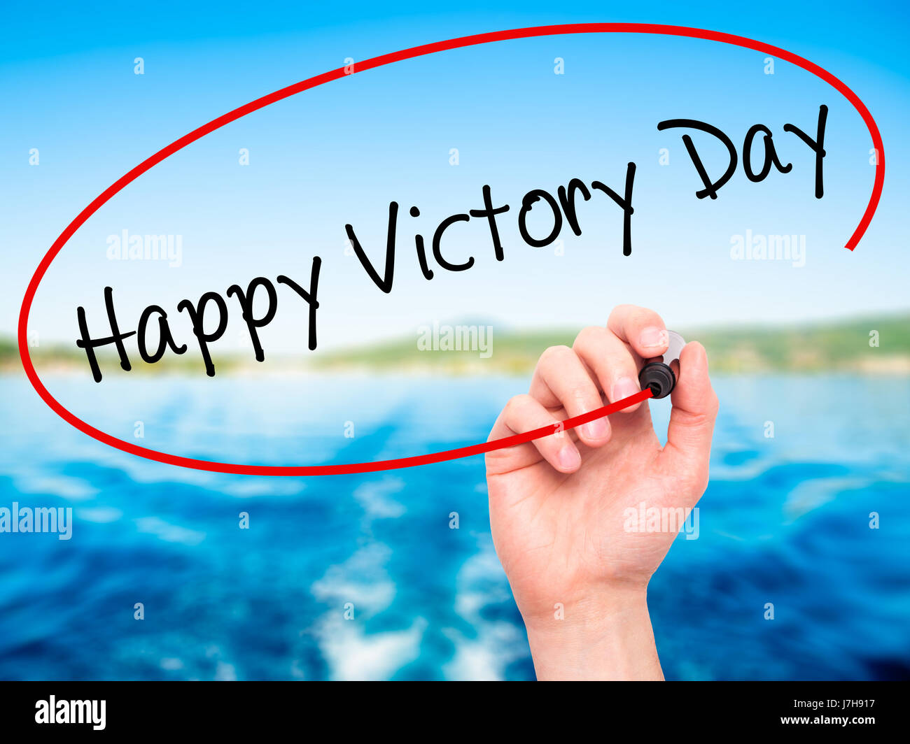 Man Hand writing Happy Victory Day with black marker on visual screen ...