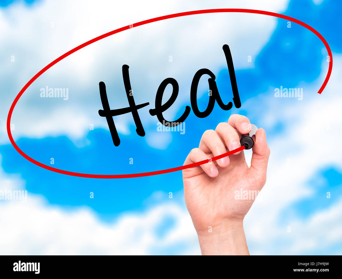 Man Hand writing Heal with black marker on visual screen. Isolated on background. Business ...