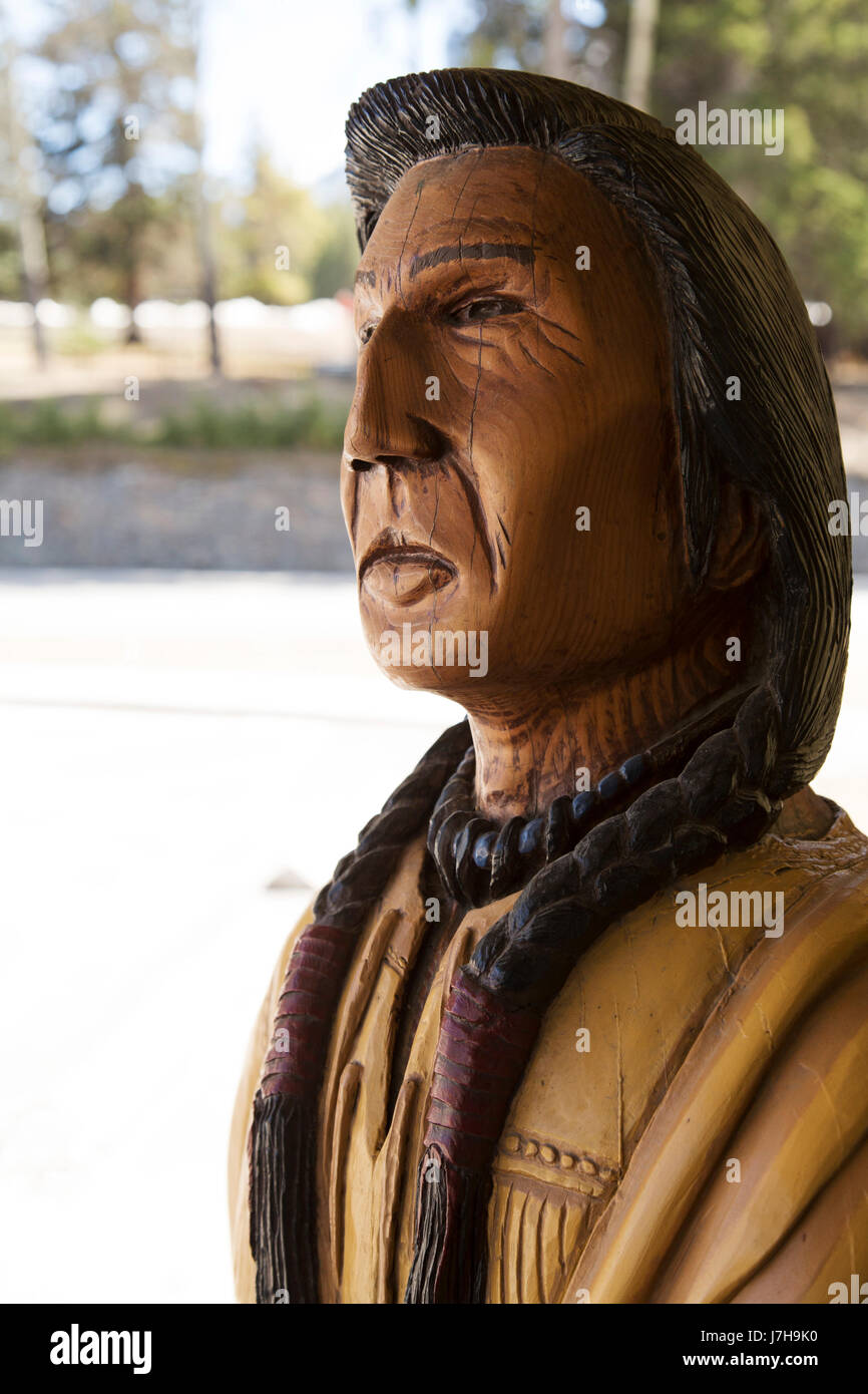 Sculpture depicting a First Nationas male oustide of the Indian Trading ...