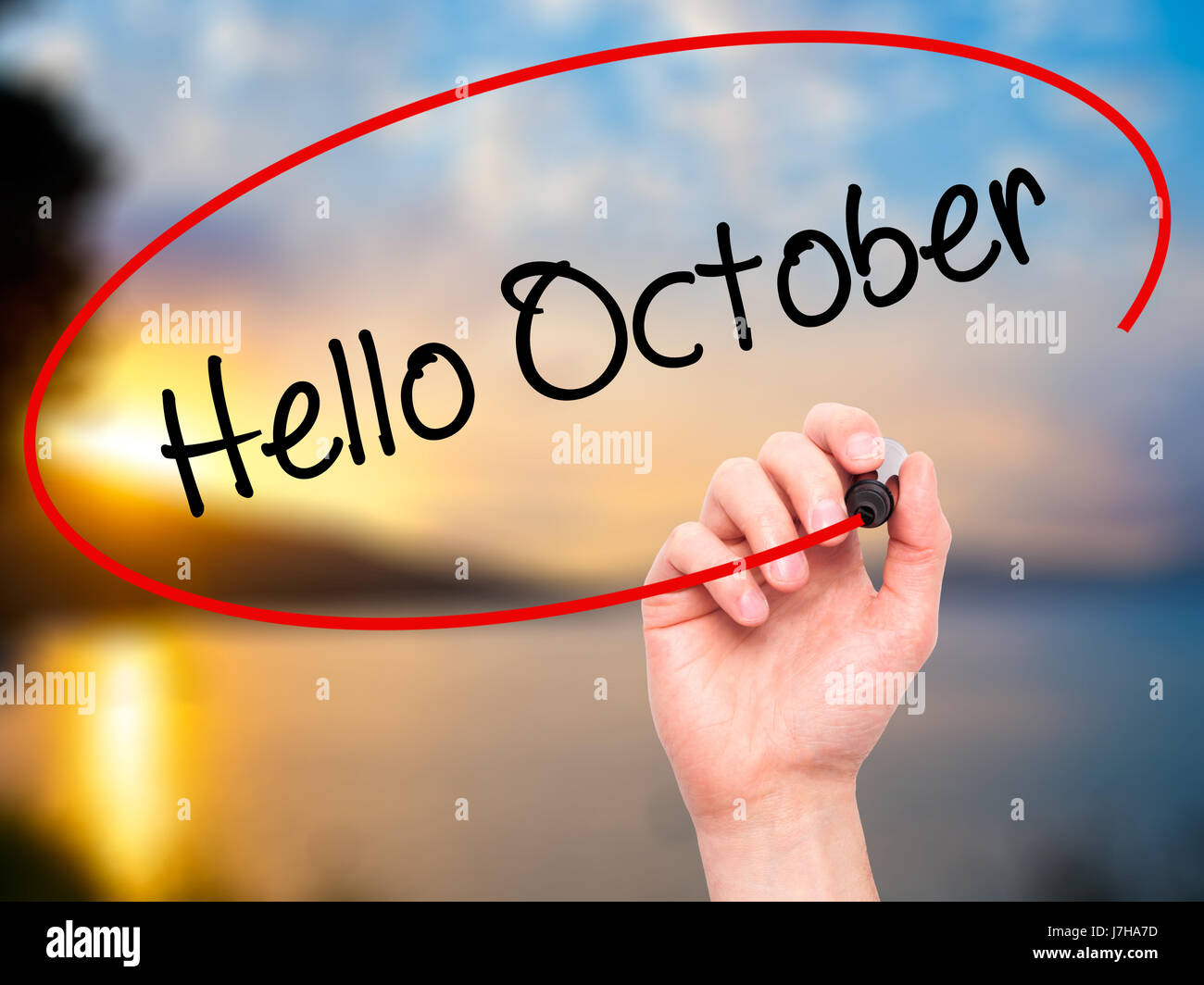 Man Hand writing Hello October with black marker on visual screen ...