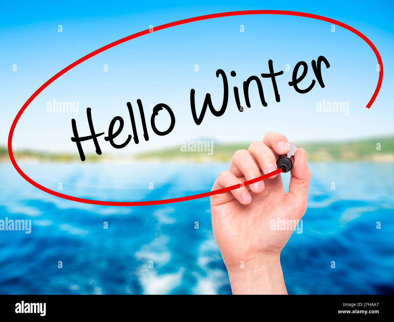 Man Hand writing Hello Winter with black marker on visual screen ...