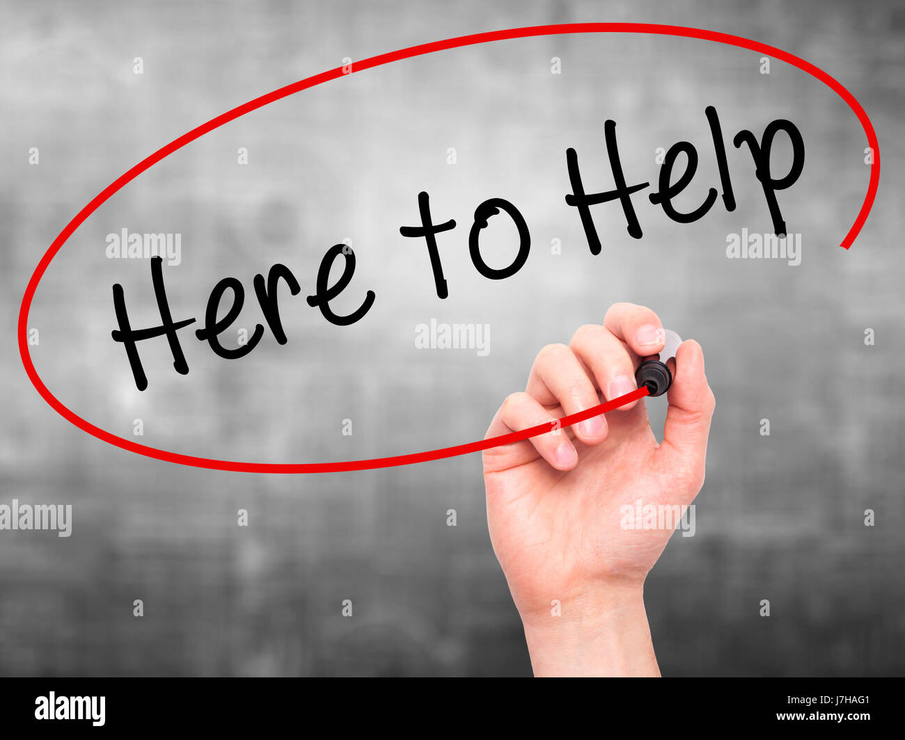 Man Hand writing Here to Help with black marker on visual screen ...