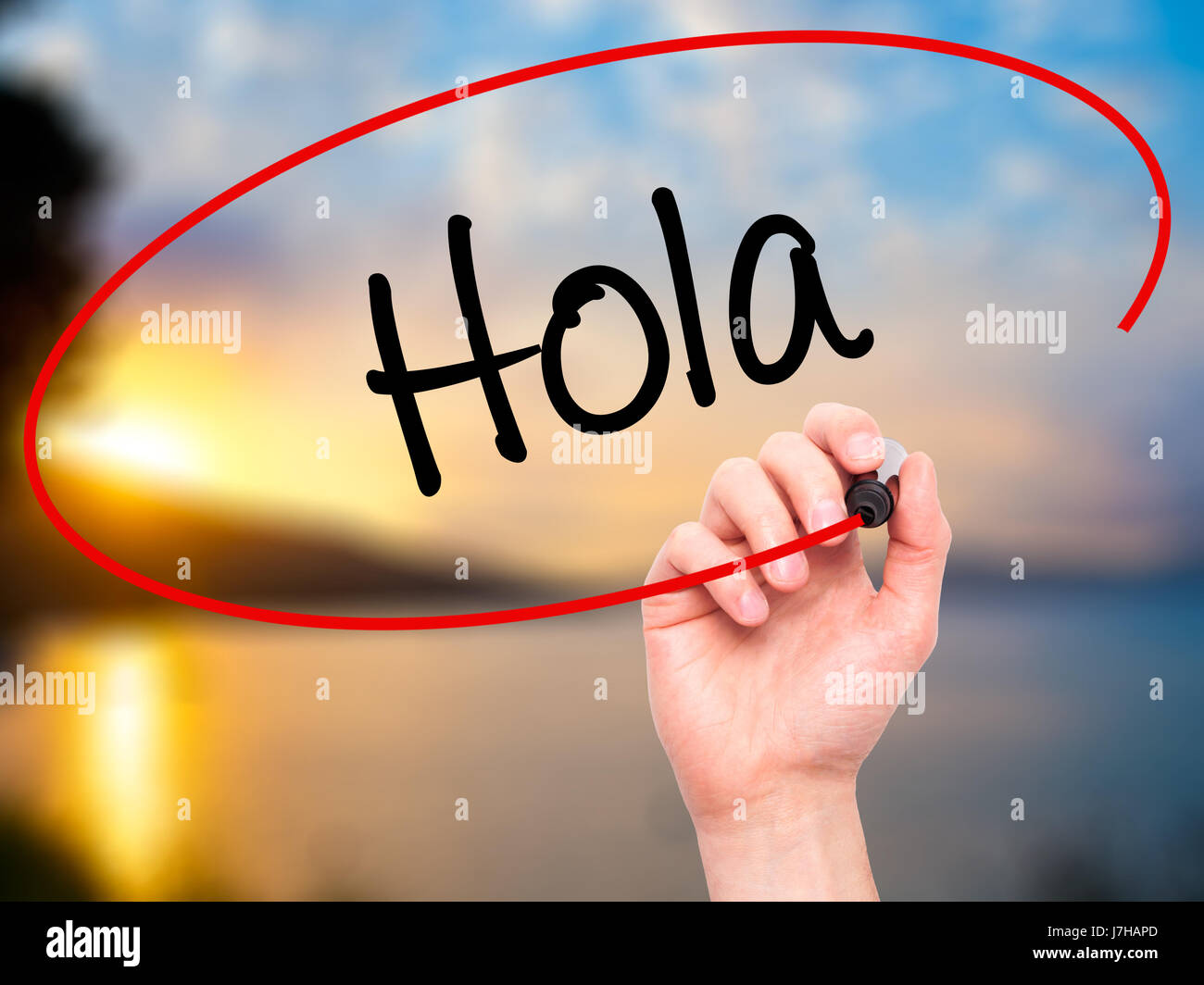 Man Hand writing Hola (Hello in Spanish) with black marker on visual ...