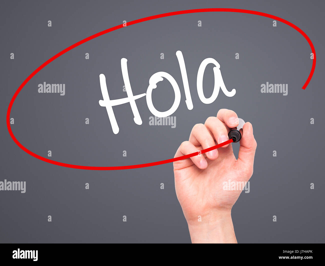 Man Hand writing Hola (Hello in Spanish) with black marker on visual ...