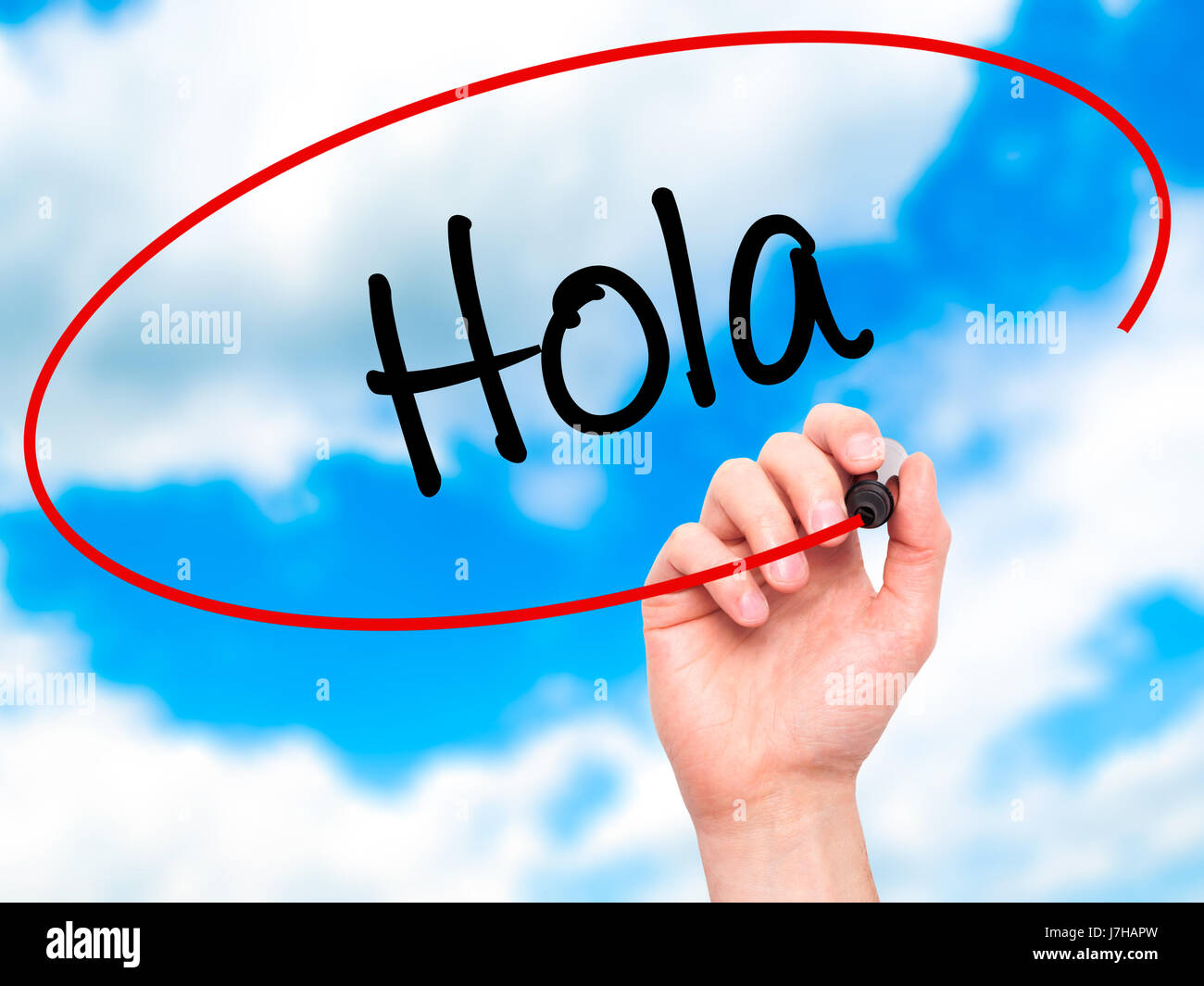 Man Hand writing Hola (Hello in Spanish) with black marker on visual ...
