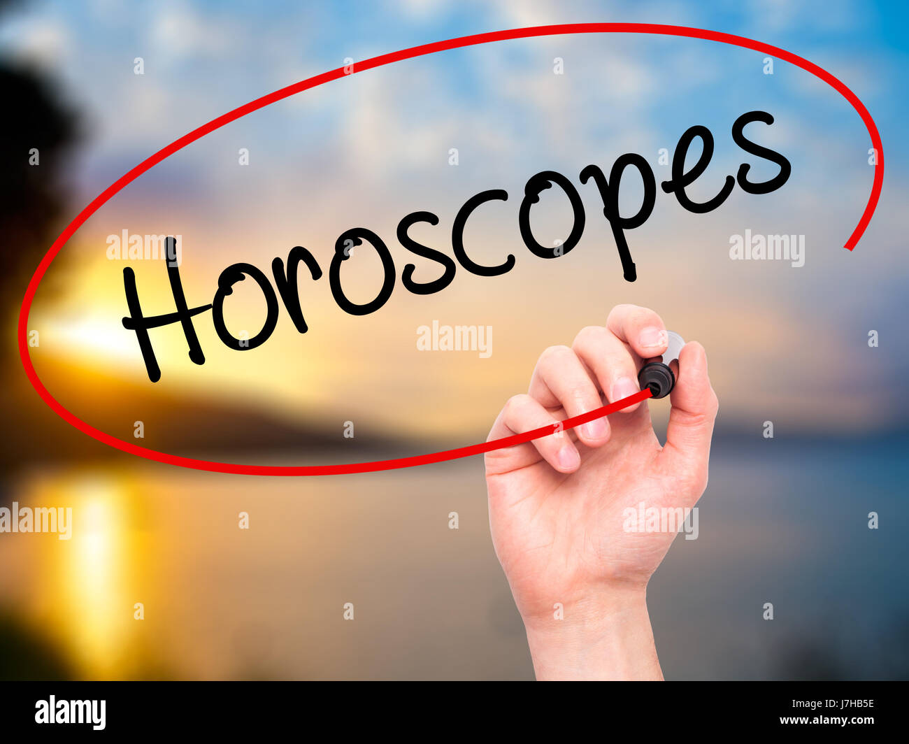 Man Hand writing Horoscopes with black marker on visual screen ...