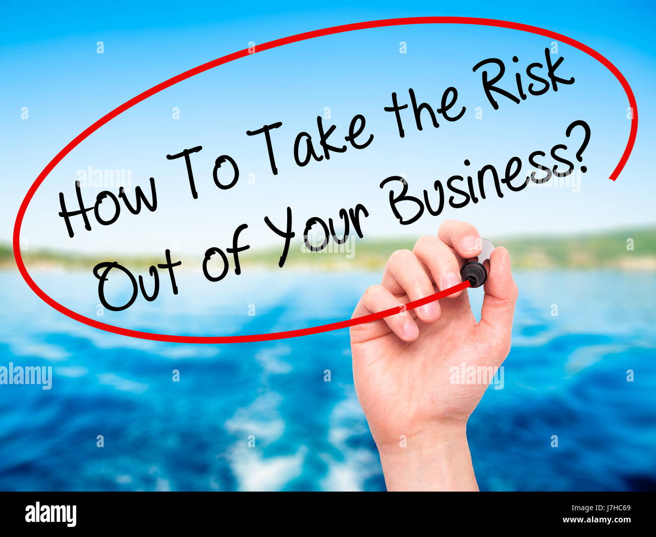 Man Hand writing How To Take the Risk Out of Your Business? with black ...