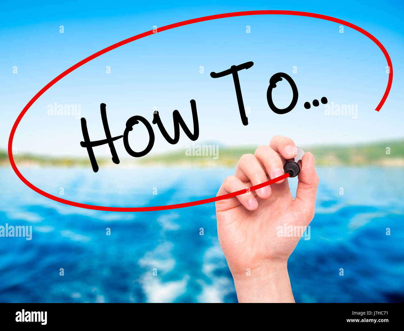 Man Hand writing How To... with black marker on visual screen. Isolated ...