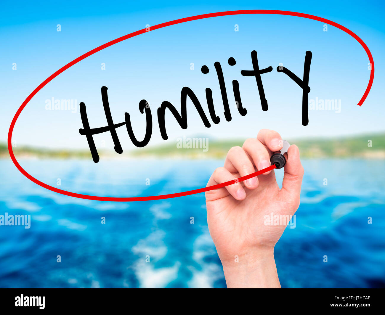 Man Hand writing Humility with black marker on visual screen. Isolated ...