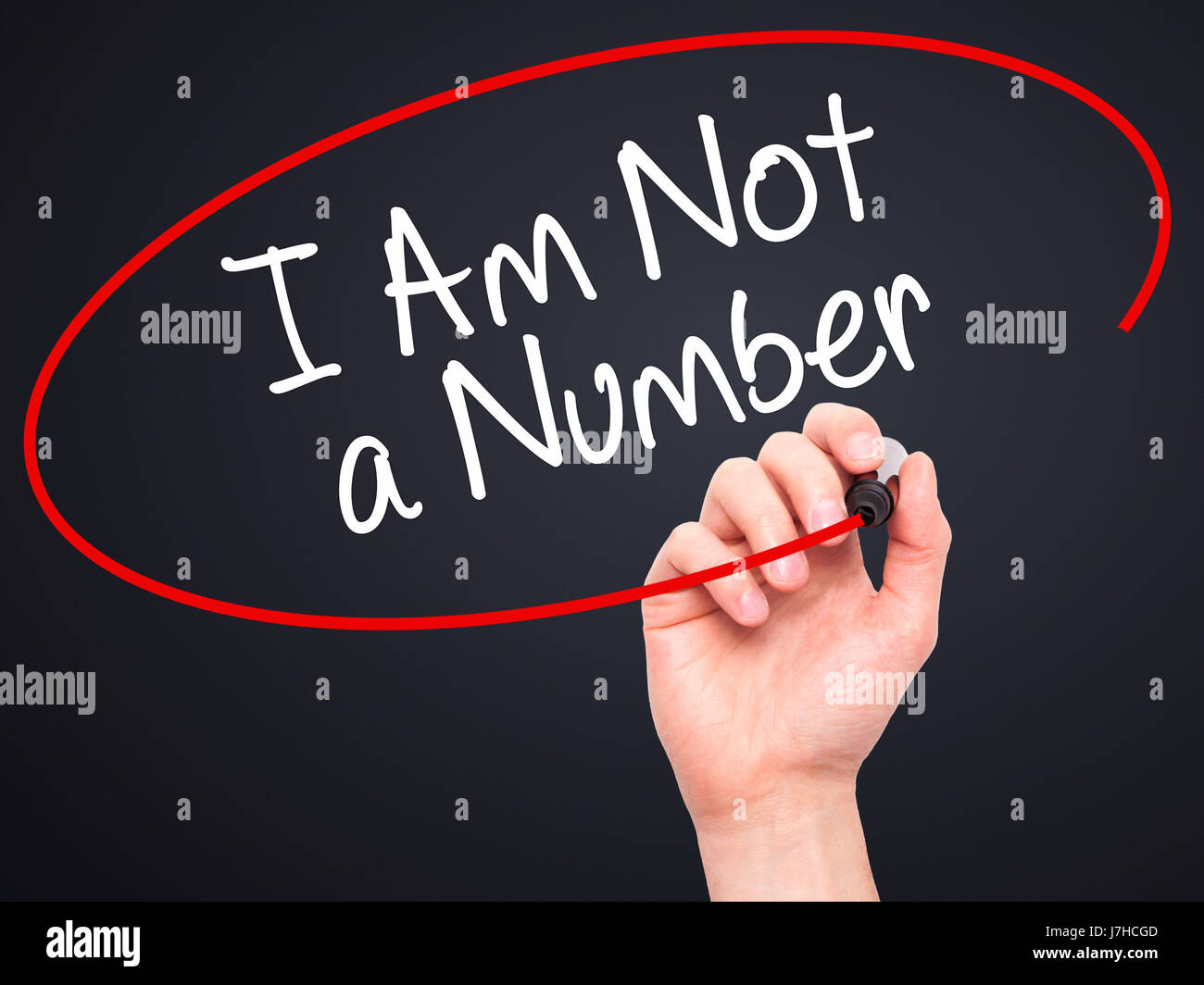 Man Hand writing I Am Not a Number with black marker on visual screen ...