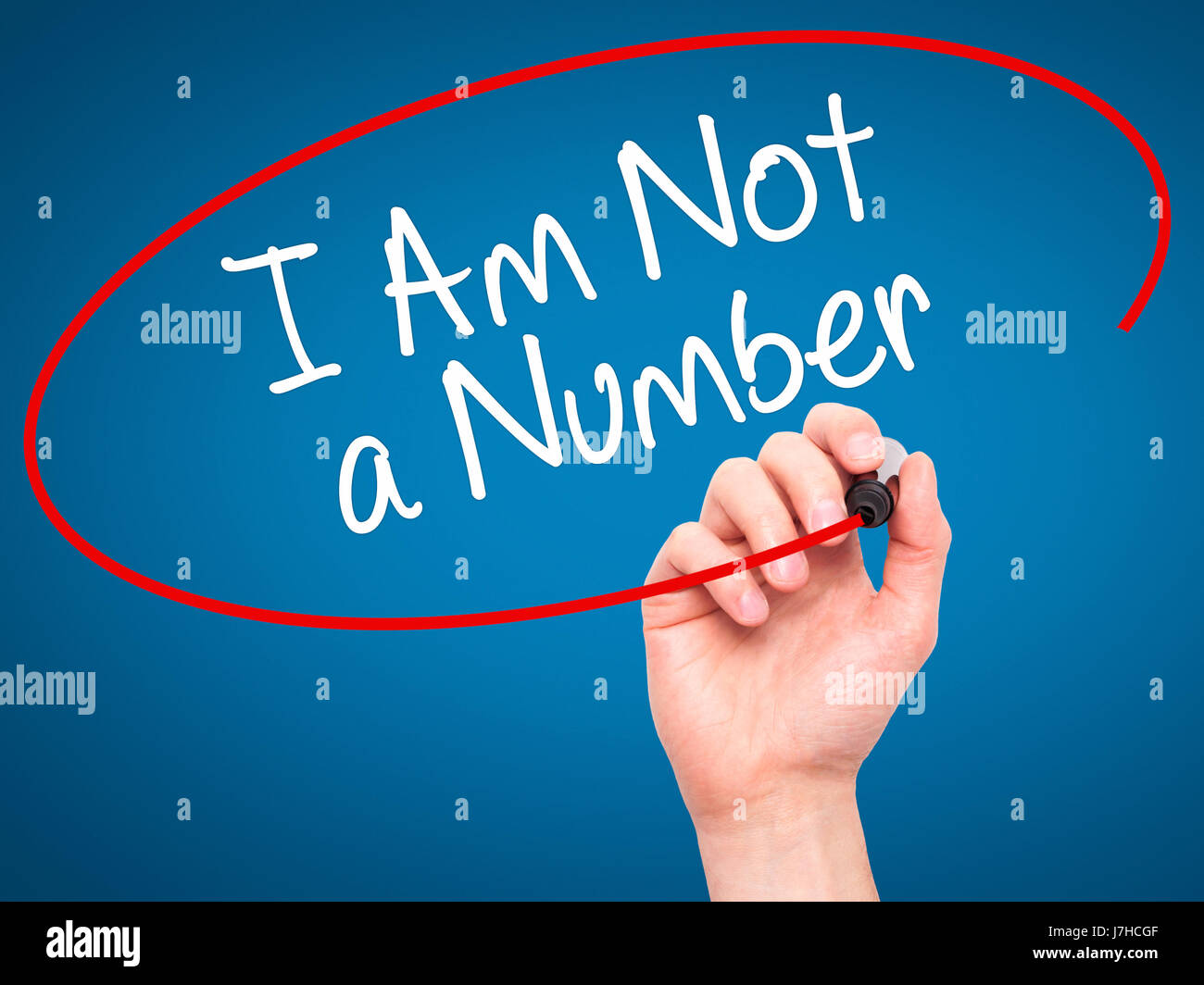 Man Hand writing I Am Not a Number with black marker on visual screen ...