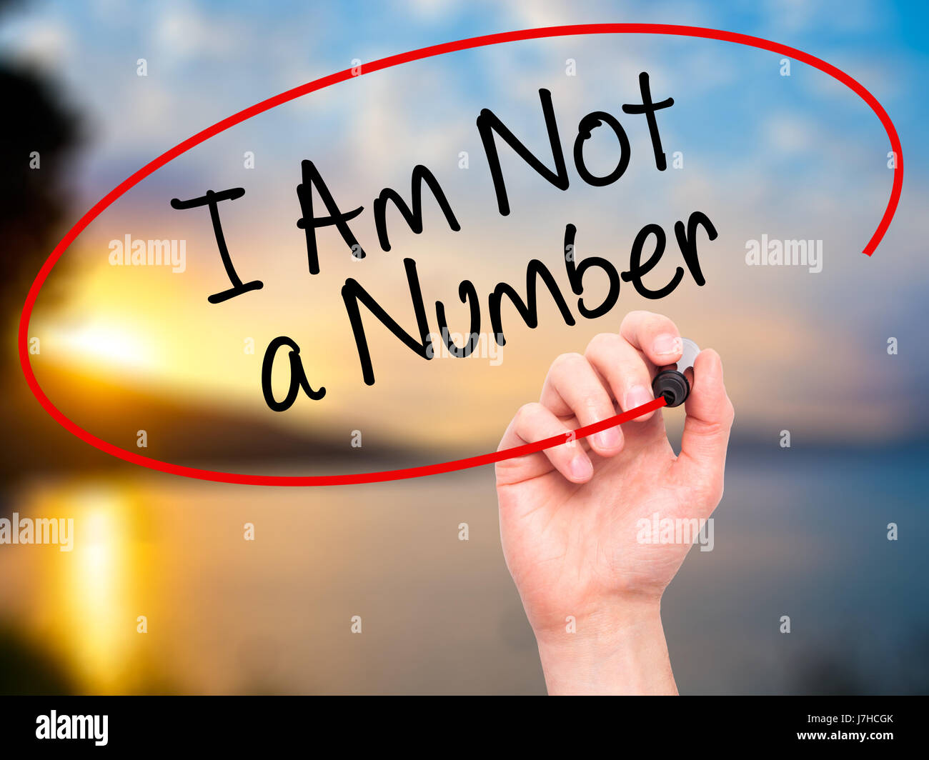 Man Hand writing I Am Not a Number with black marker on visual screen ...