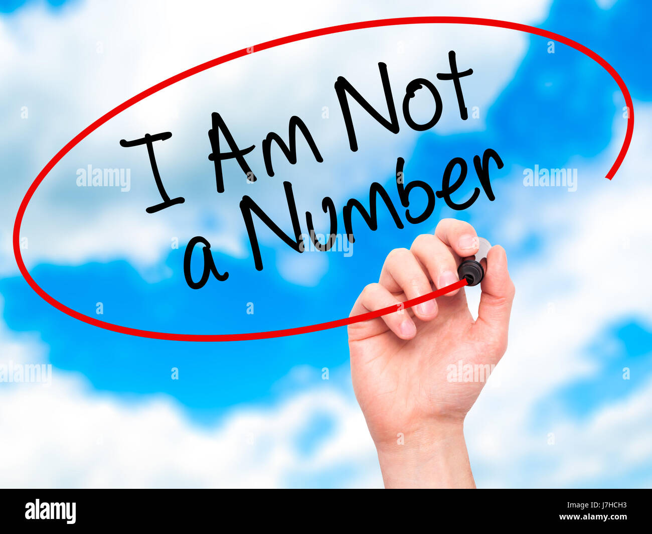 Man Hand writing I Am Not a Number with black marker on visual screen ...