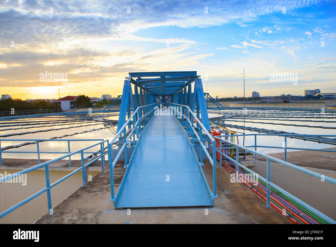 perspective of metal bridge for working in big tank of water supply in ...