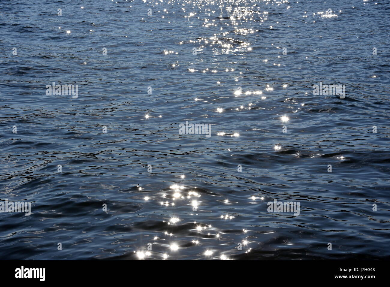 Close-up of blue water, sparkling water. Small light reflection on the ...