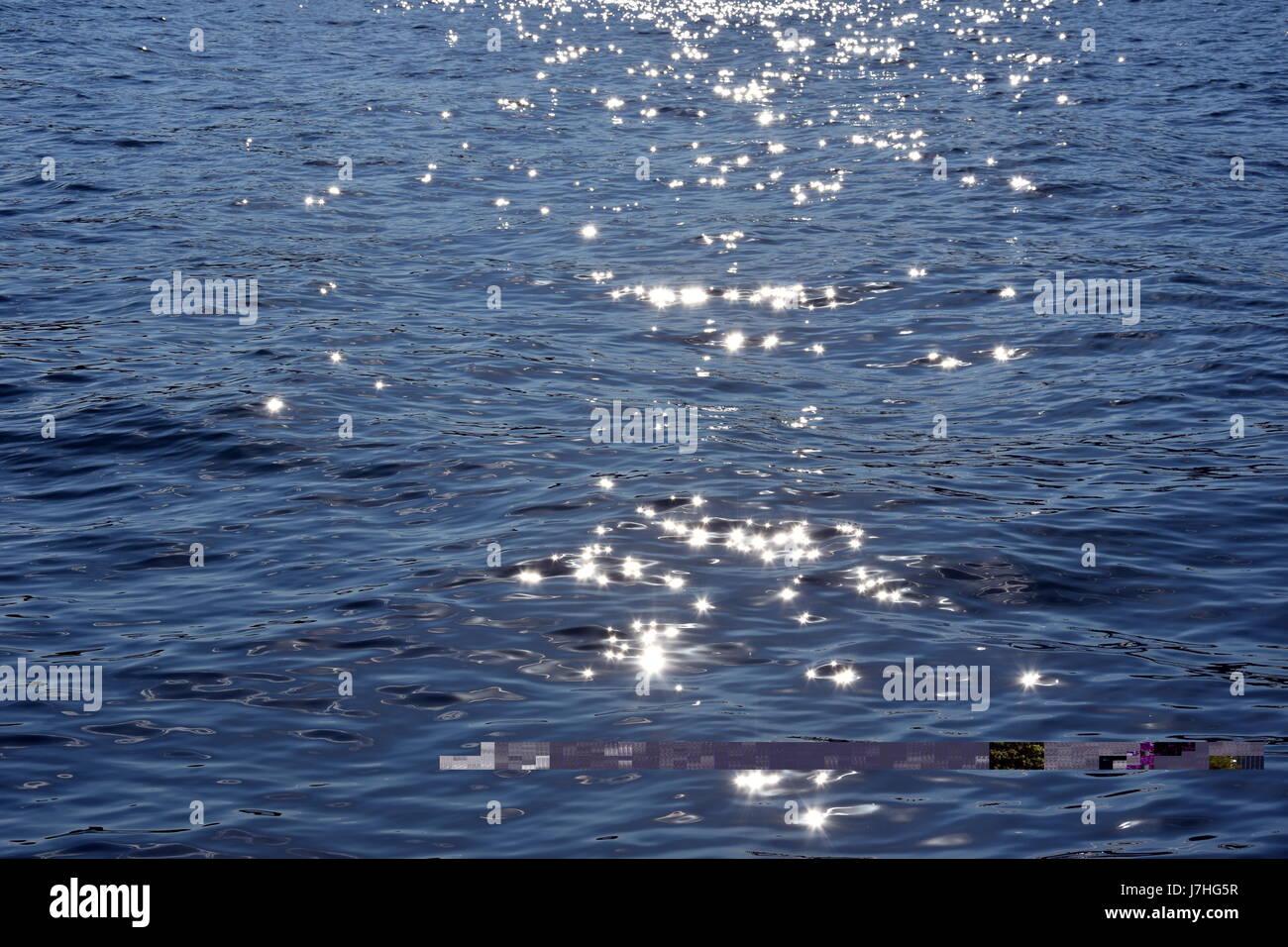 Close-up of blue water, sparkling water. Small light reflection on the ...