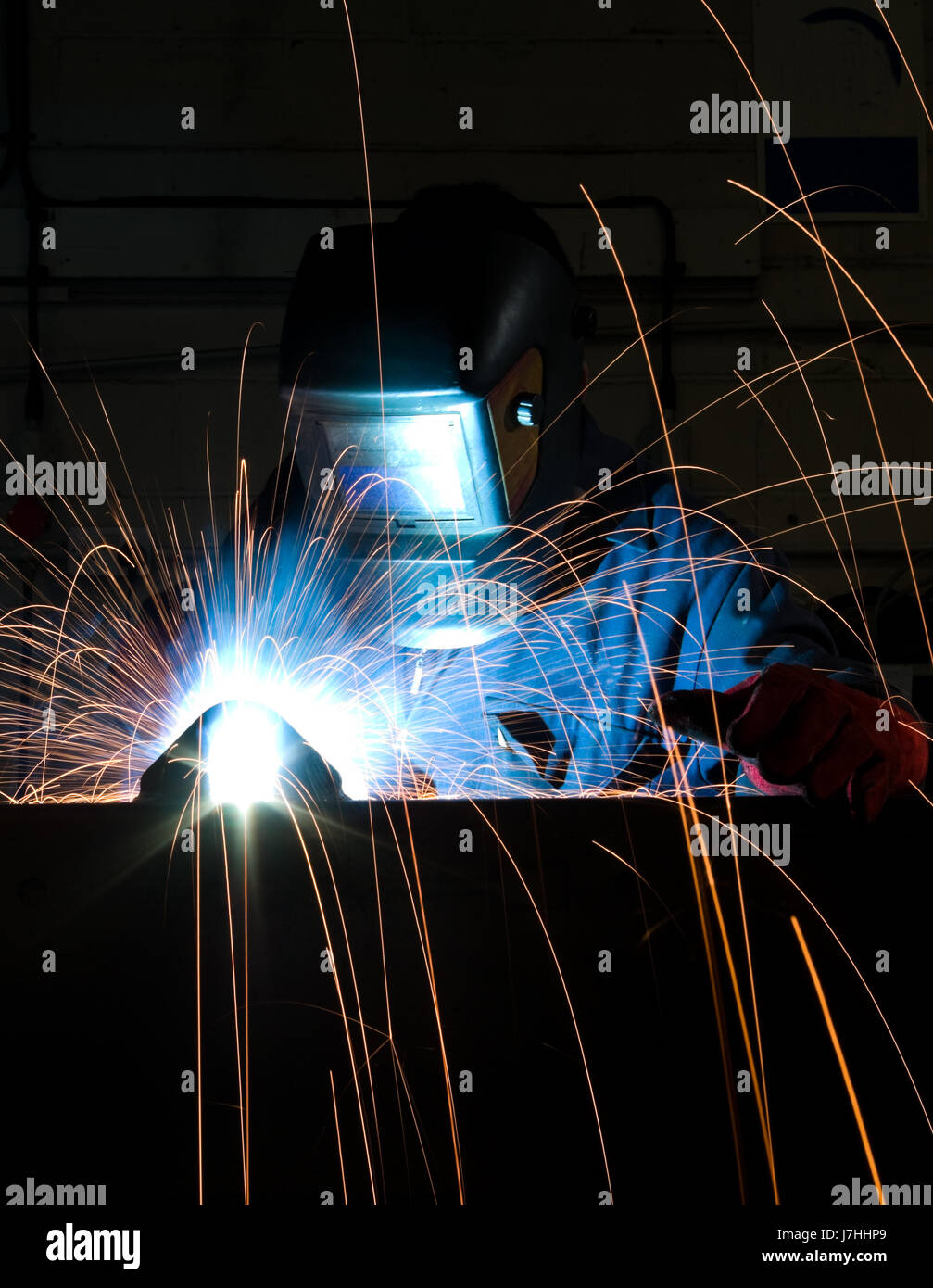 engineering manufacturing welding sparks welder blue colour workshop ...