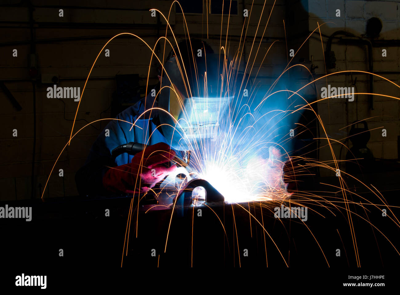 engineering manufacturing welding sparks welder blue colour workshop ...