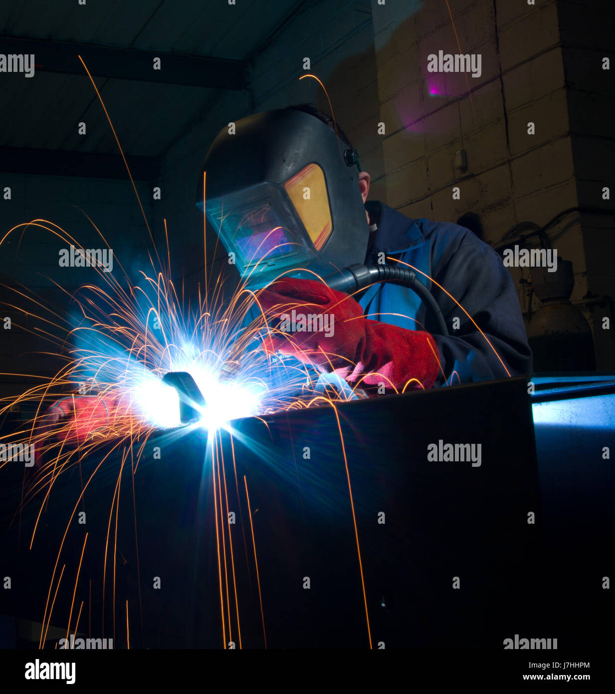 engineering manufacturing welding sparks welder blue colour workshop ...