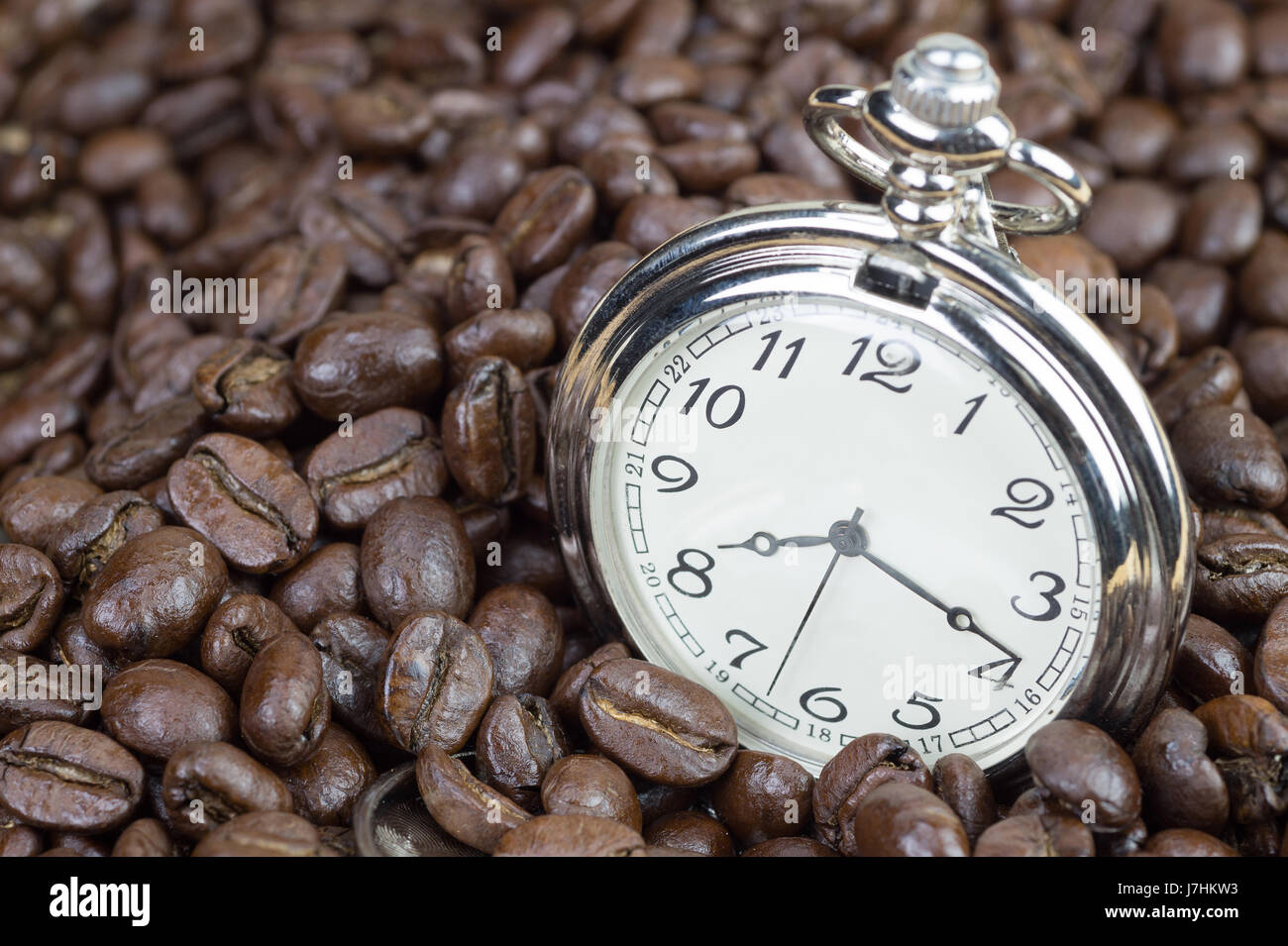 Classic pocket watch on coffee beans background Stock Photo - Alamy