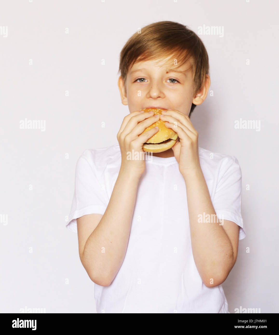 Boy eating burger party hi-res stock photography and images - Alamy