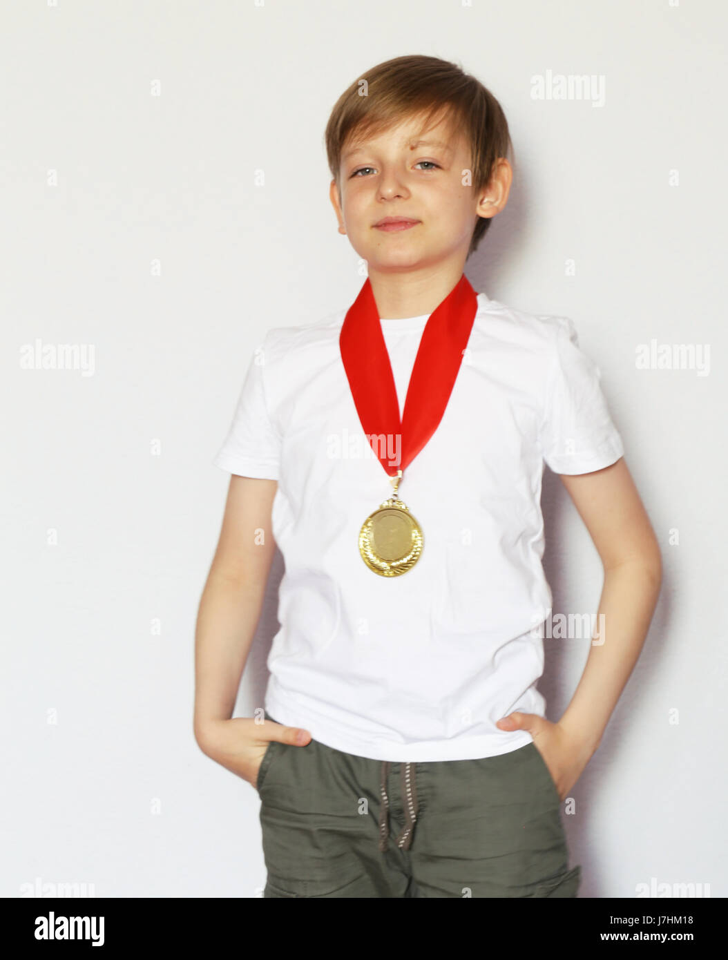 Cute blonde boy with gold medal winner Stock Photo - Alamy