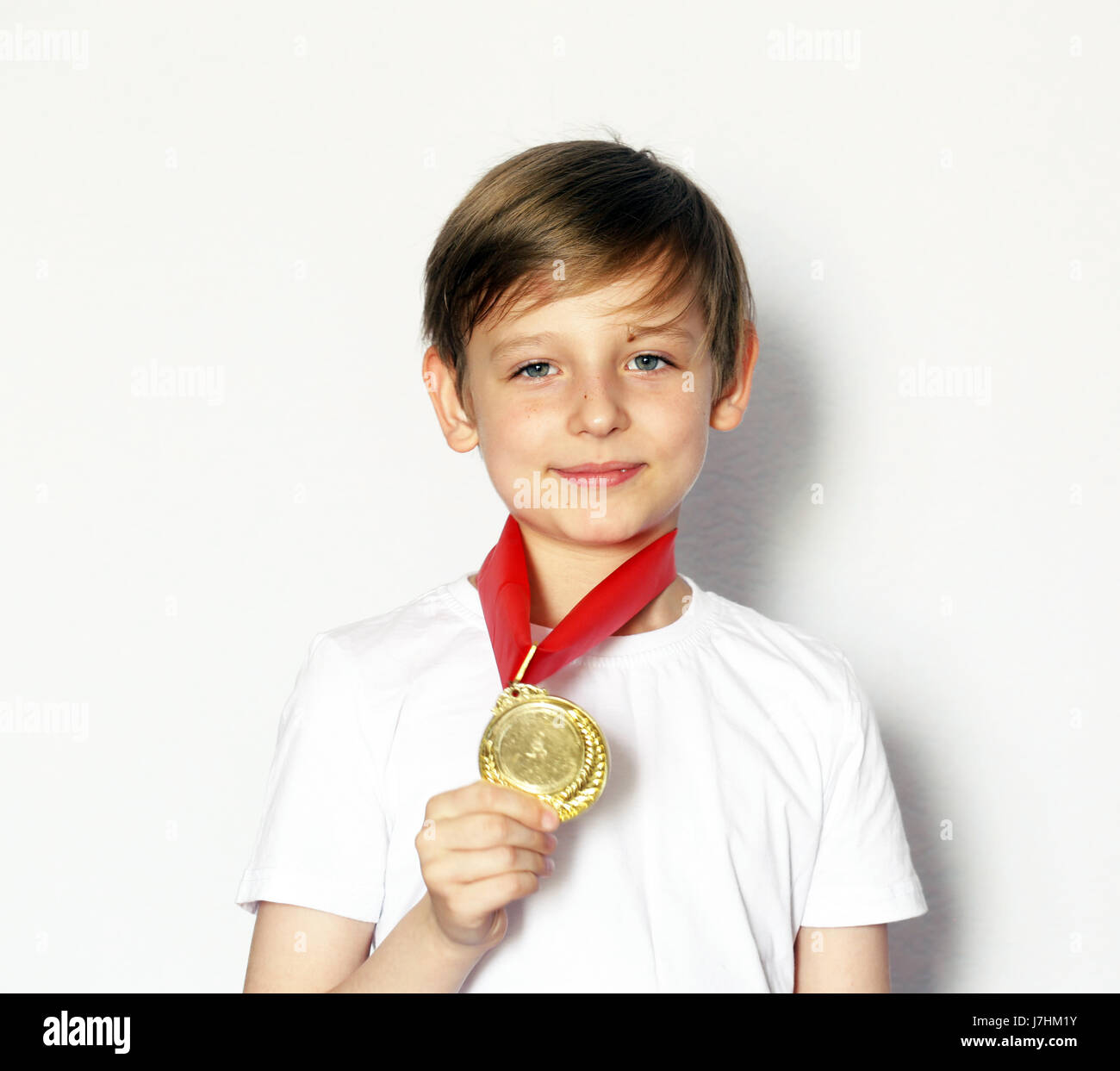 Cute blonde boy with gold medal winner Stock Photo - Alamy