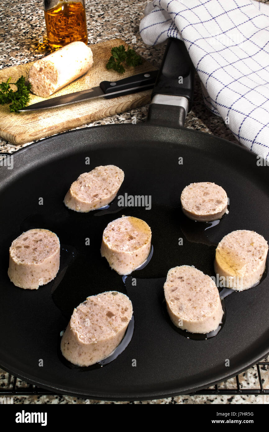 raw irish white pudding with sunflower oil in a pan Stock Photo - Alamy