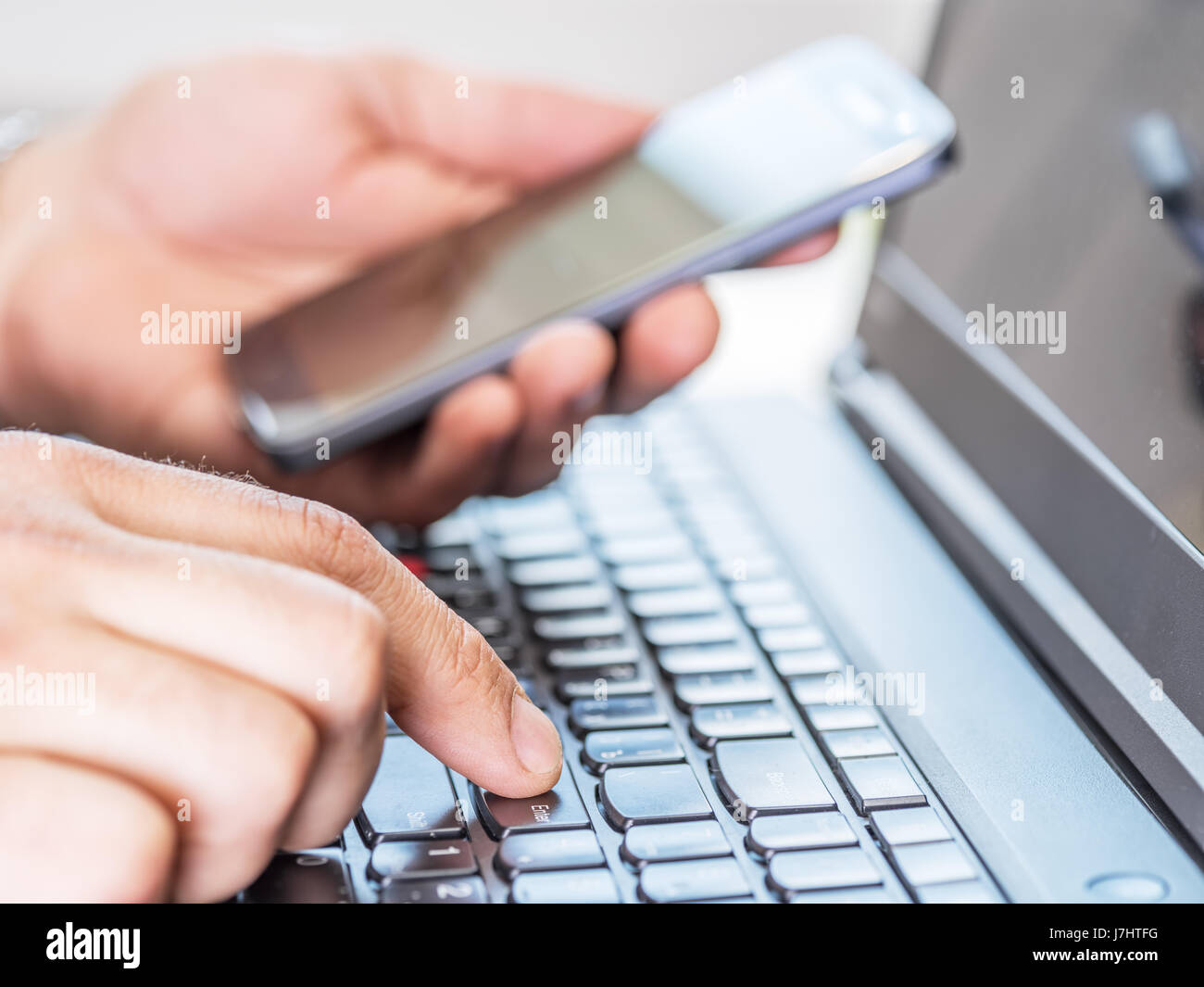 Online shopping using mobile telephone and laptop Stock Photo - Alamy