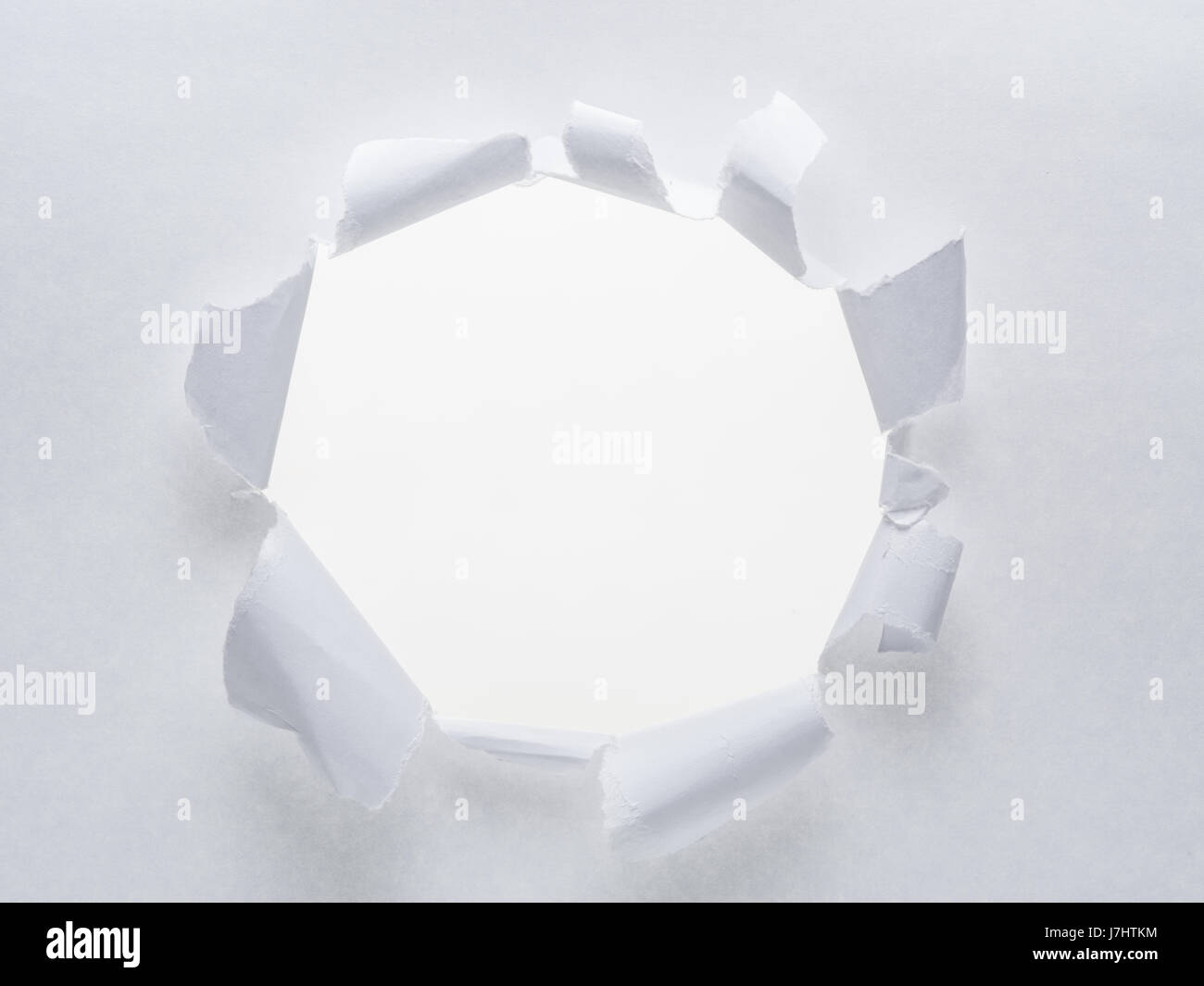 Hole on a paper. White background Stock Photo - Alamy