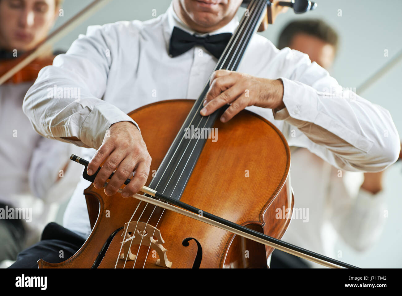 Cellist and violinist playing at the concert Stock Photo - Alamy