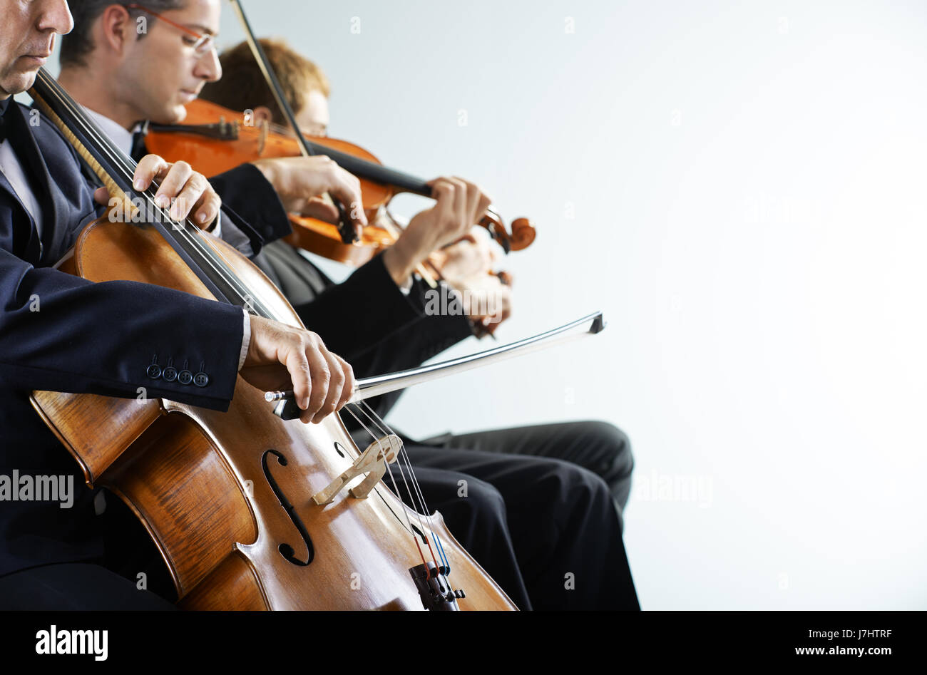 Cellist and violinist playing at the concert Stock Photo - Alamy