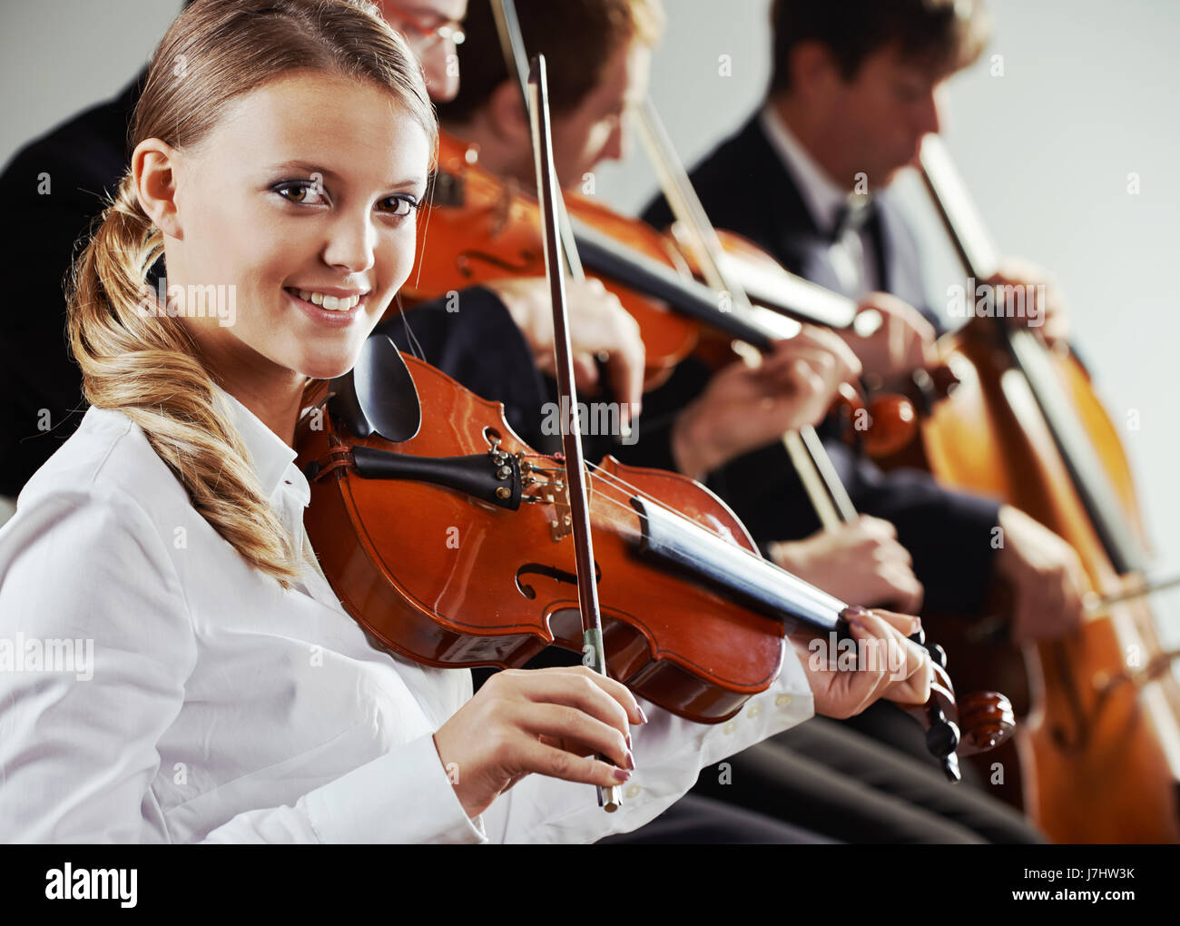 Musicians in concert, beautiful female violinist on foreground Stock ...